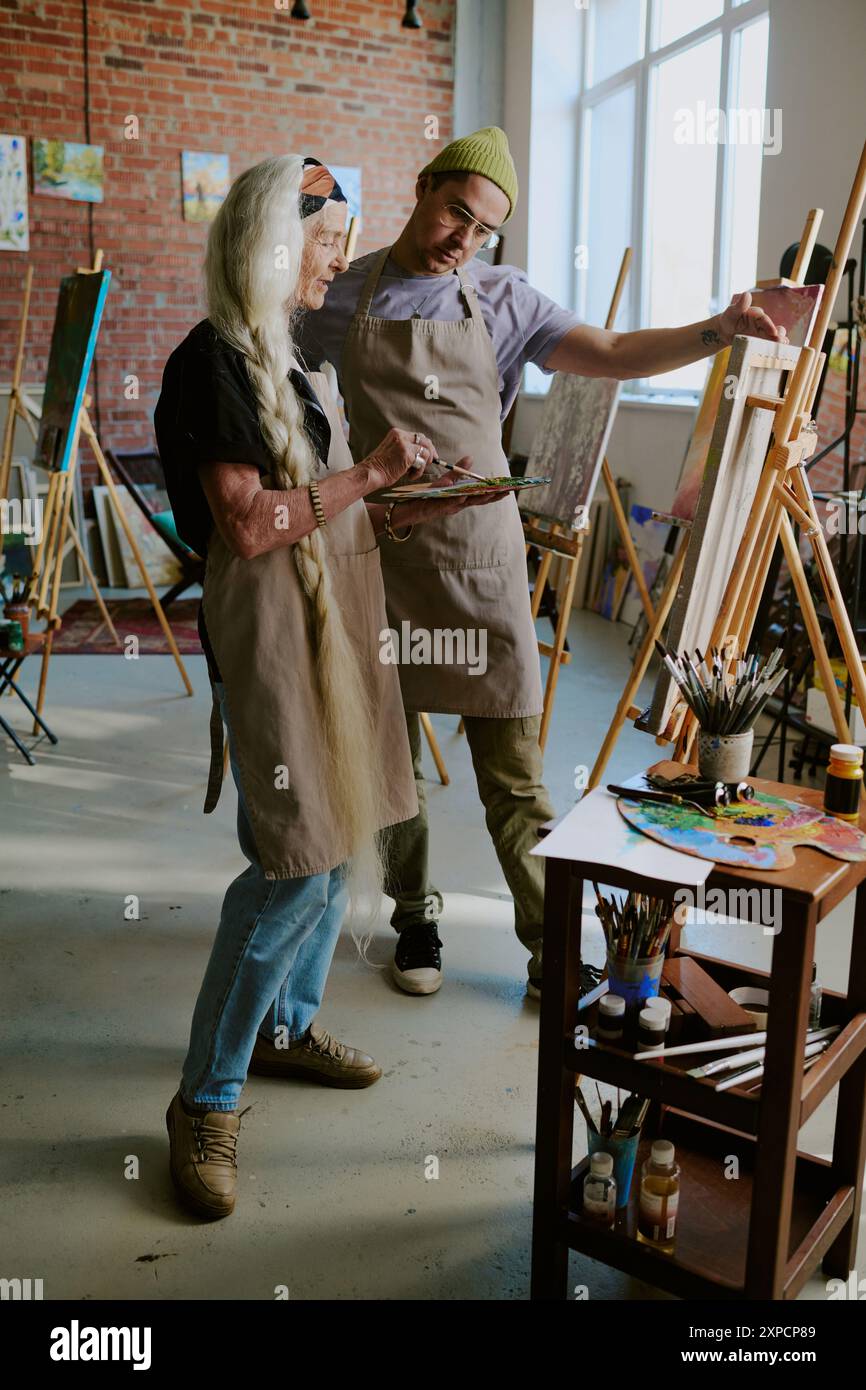 Vertical long shot of modern senior Caucasian woman having individual ...
