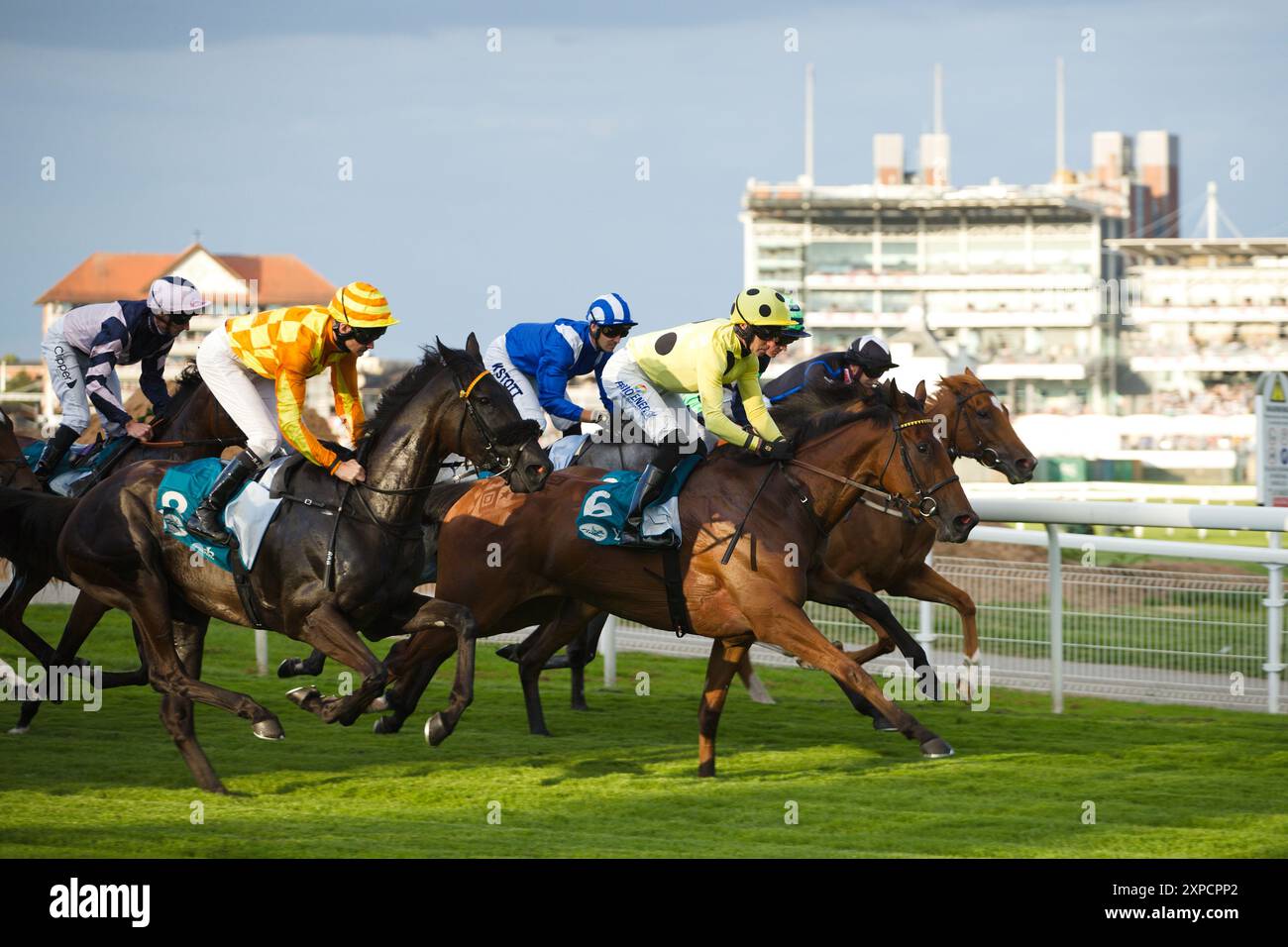 Jockeys gallop from the starting gate at York including Robert Havlin ...