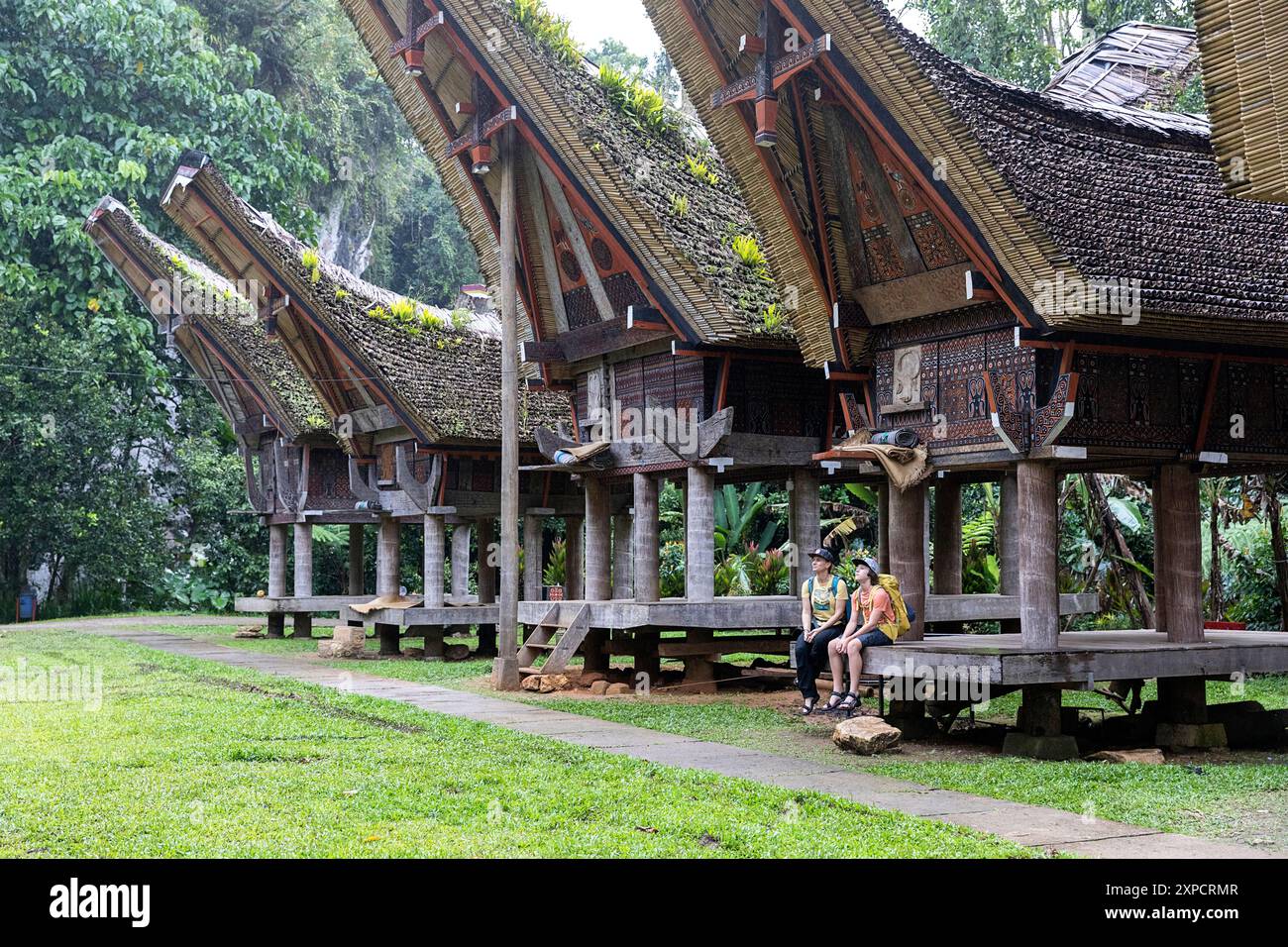 Mother and son, tourists sitting at rice barns in Buntu Pune ...