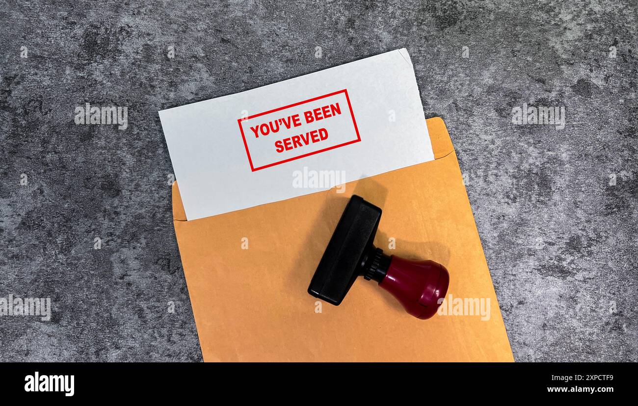Red Handle Rubber Stamper and You've been served text above brown ...