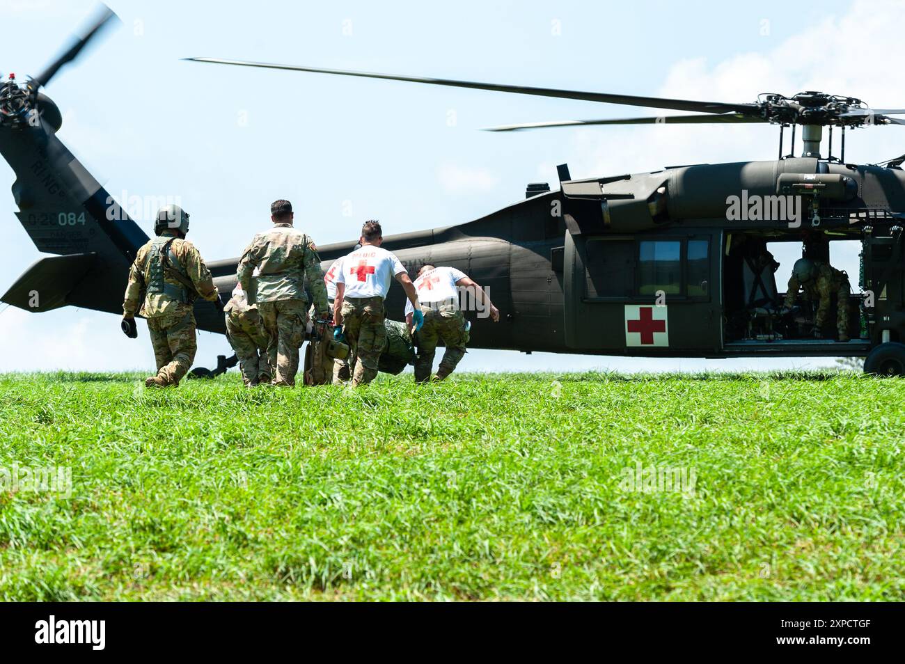 United States Army Medical team attending to an injured paratrooper at ...