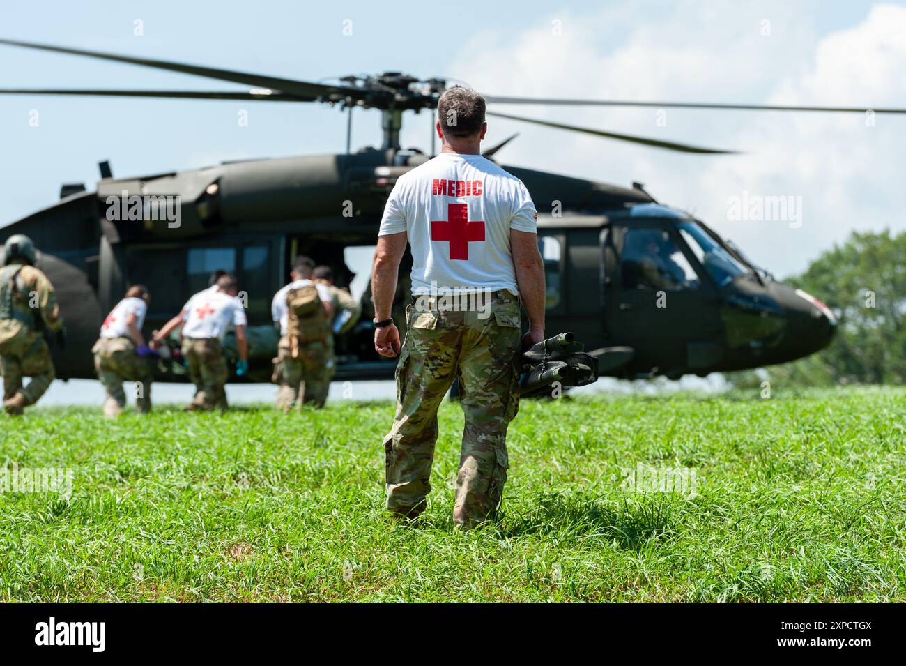 United States Army Medical team attending to an injured paratrooper at ...