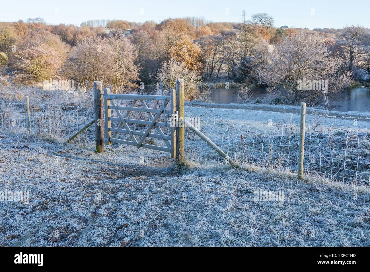 A frost covered 5 barred wooden gate next to Tong Park Dam, Baildon ...
