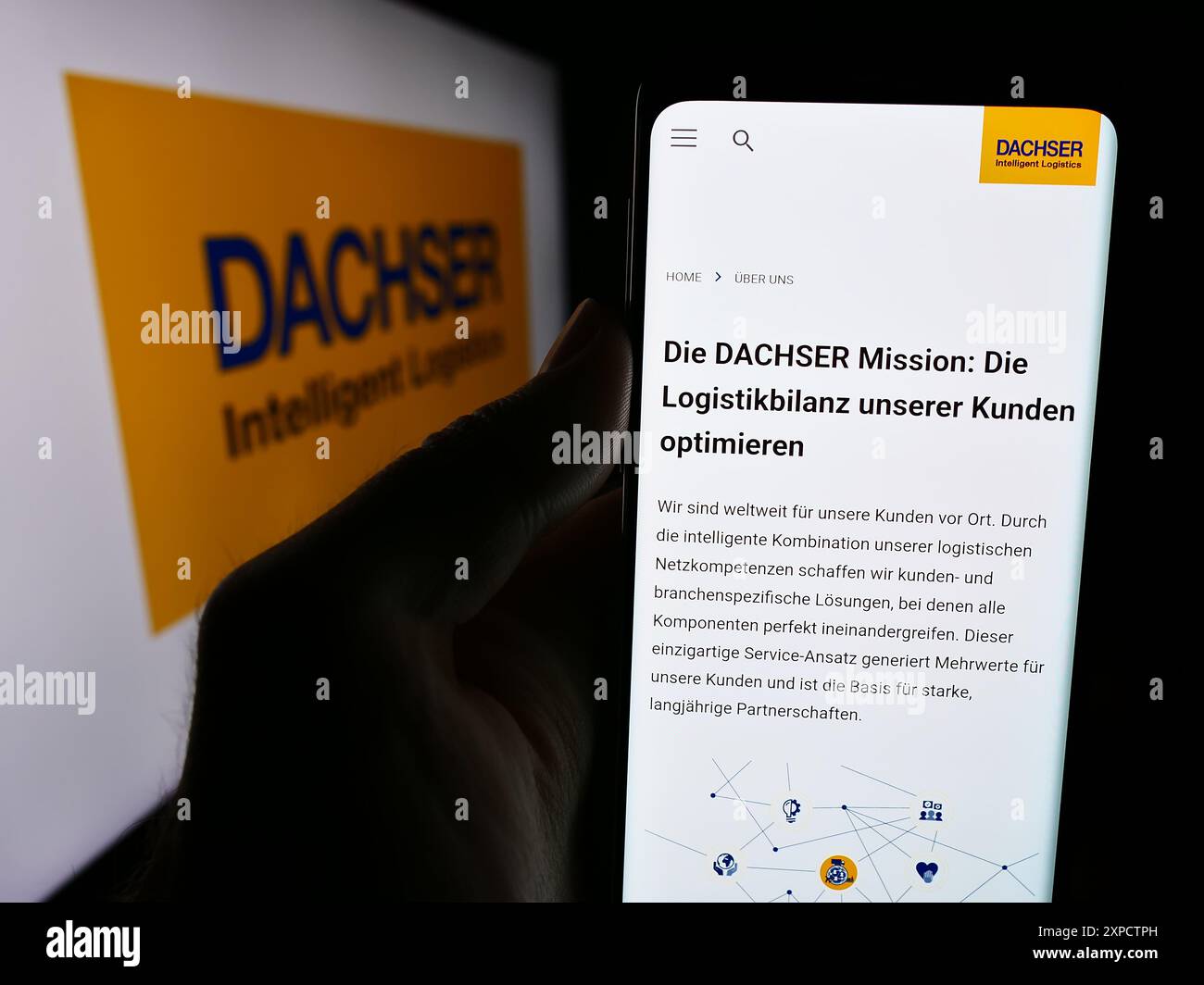 Person holding mobile phone with website of German logistics company ...