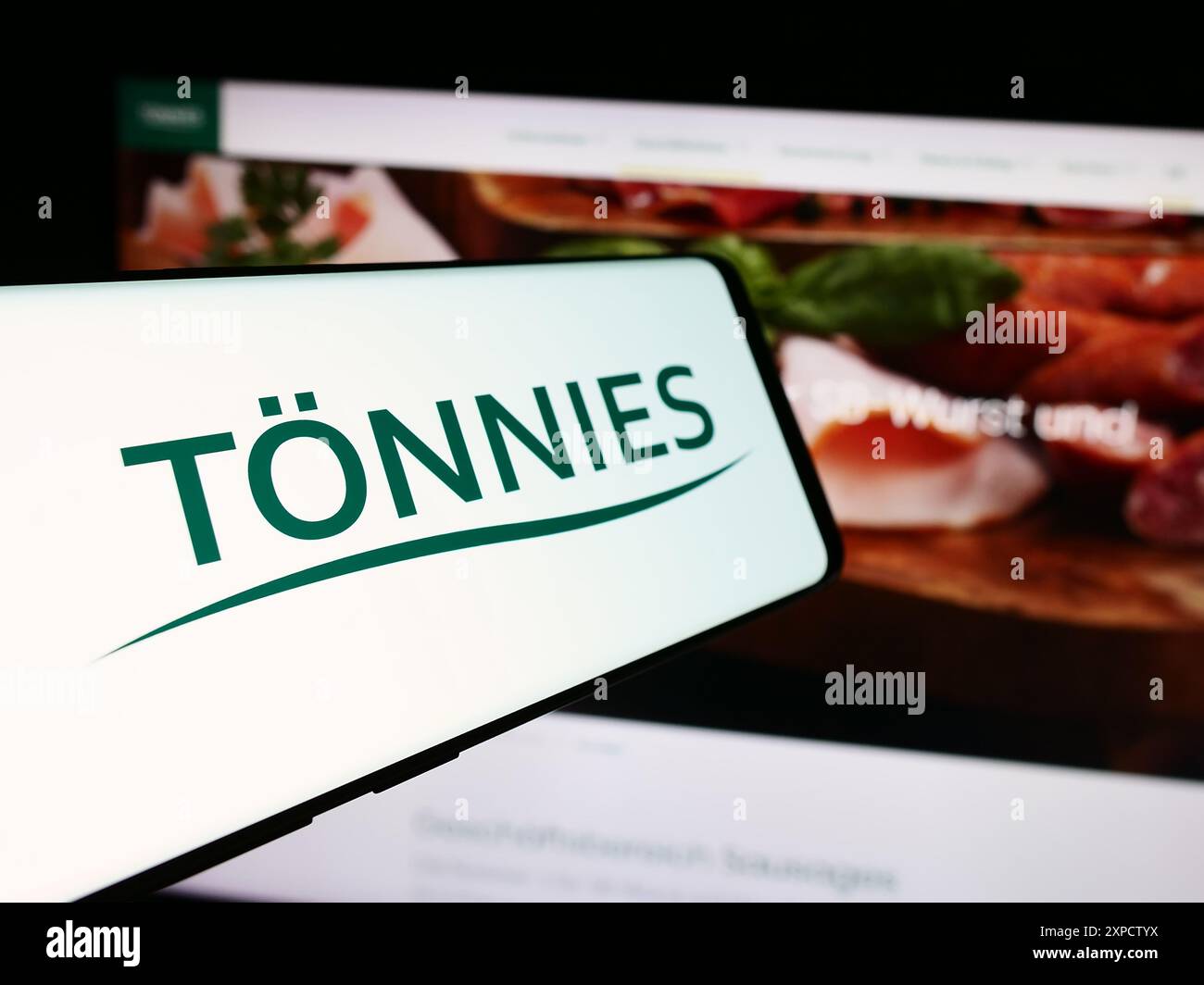 Mobile phone with logo of meat processing company Tönnies Holding ApS ...