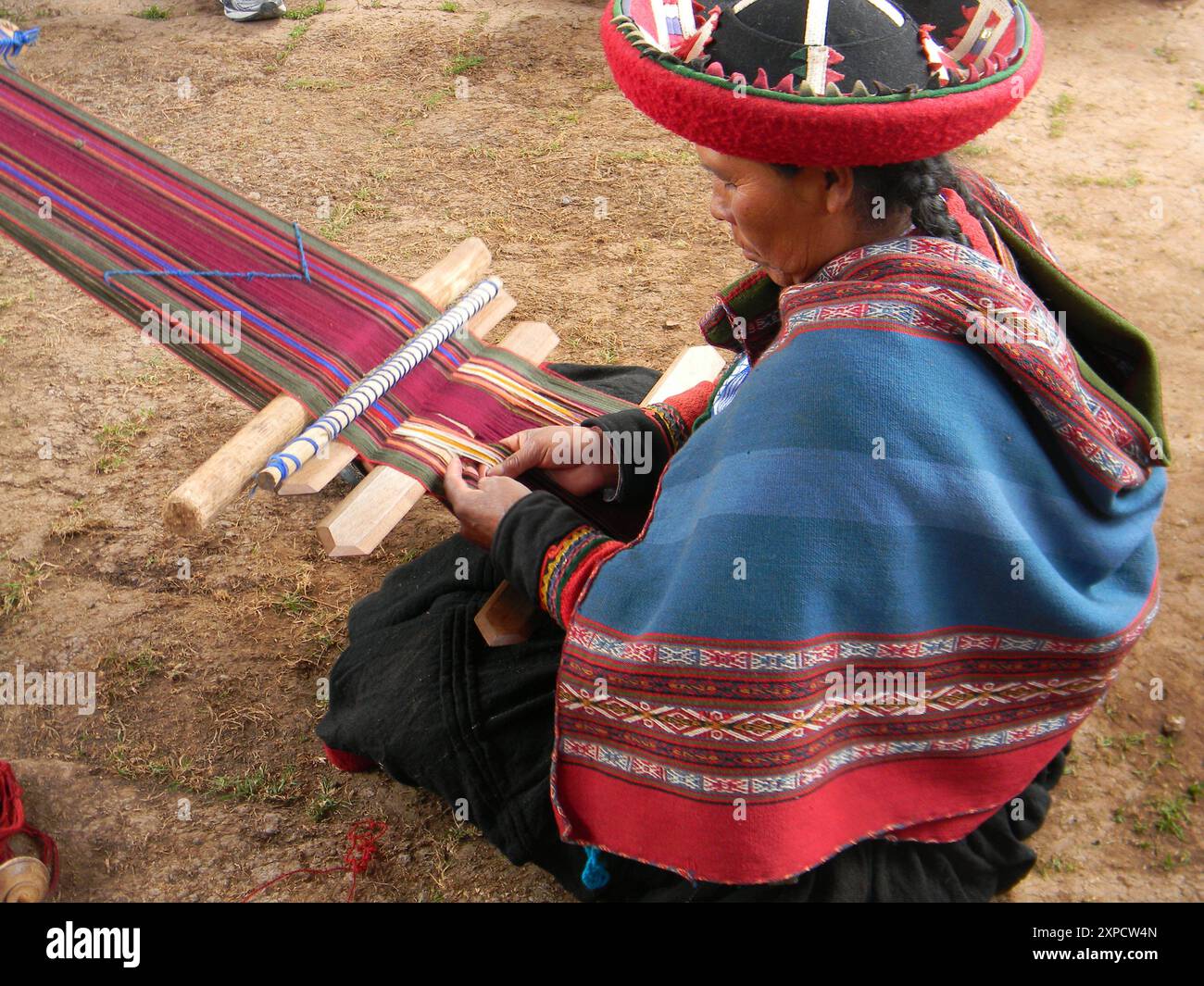 Woman working on traditional textiles in the Andes, Peru Stock Photo ...