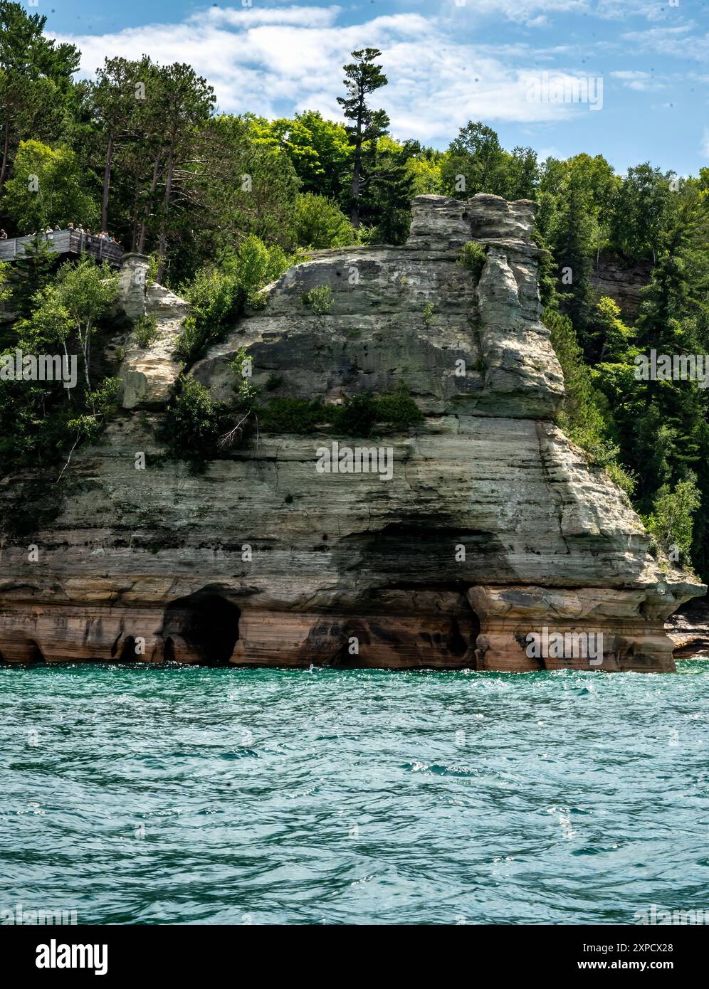 A scenic view of Pictured Rocks National Lakeshore with clear blue ...