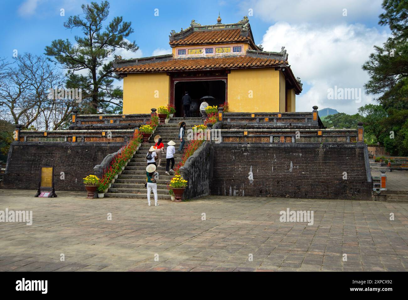 Vietnamese tourists walk around the mausoleum of ancient Vietnamese ...