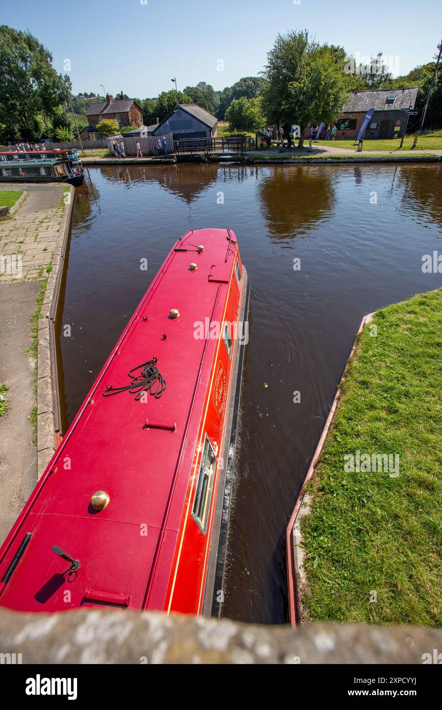 Canal narrowboat emerging out of the Llangollen canal into Trevor basin ...