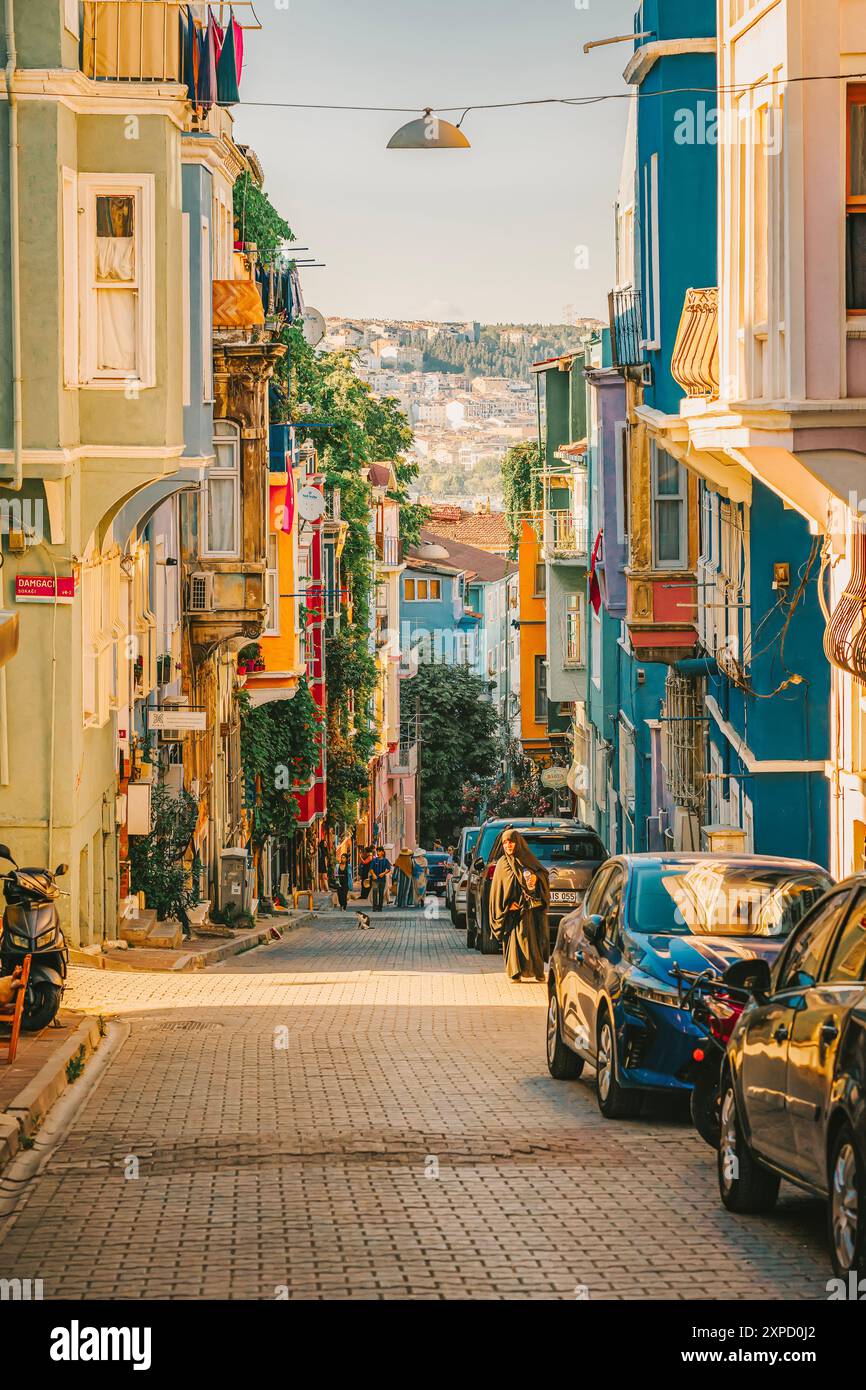 ISTANBUL, TURKEY - 30 JUNE 2024: Vibrant narrow street with parked cars ...