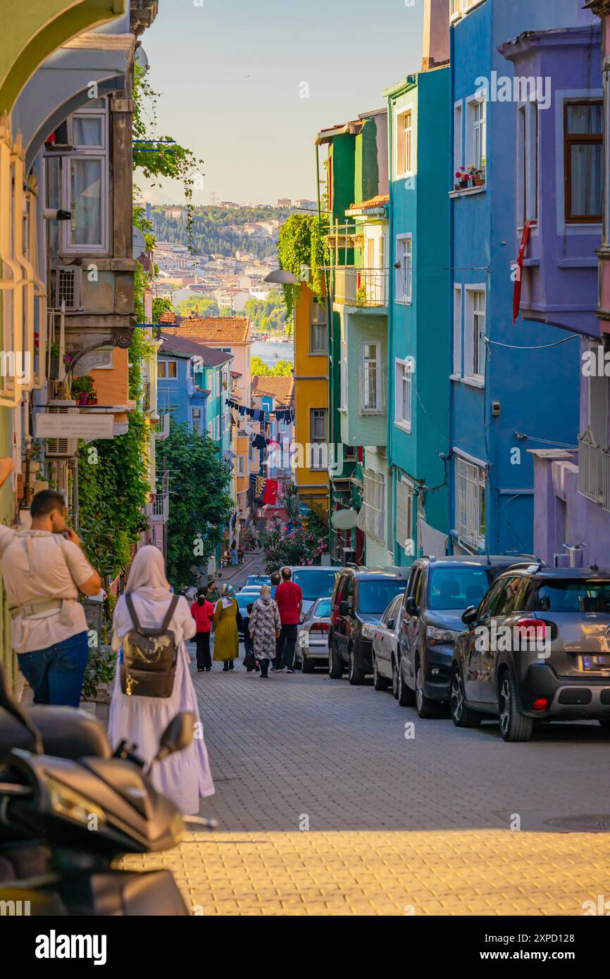 Colorful urban street with people walking, parked cars, vibrant ...