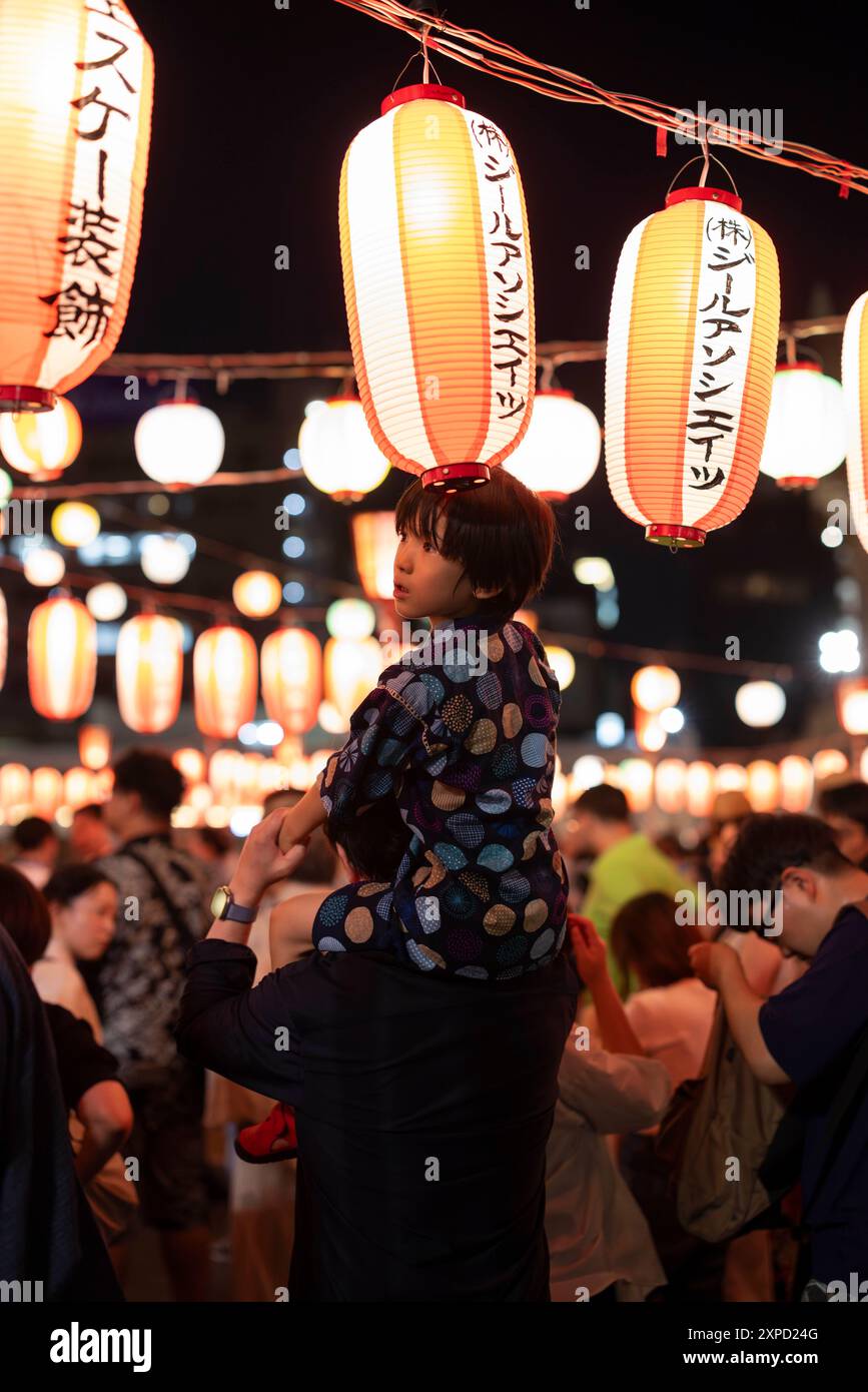 Tokyo, Japan. 03rd Aug, 2024. Boy sits on his fathers shoulders during ...