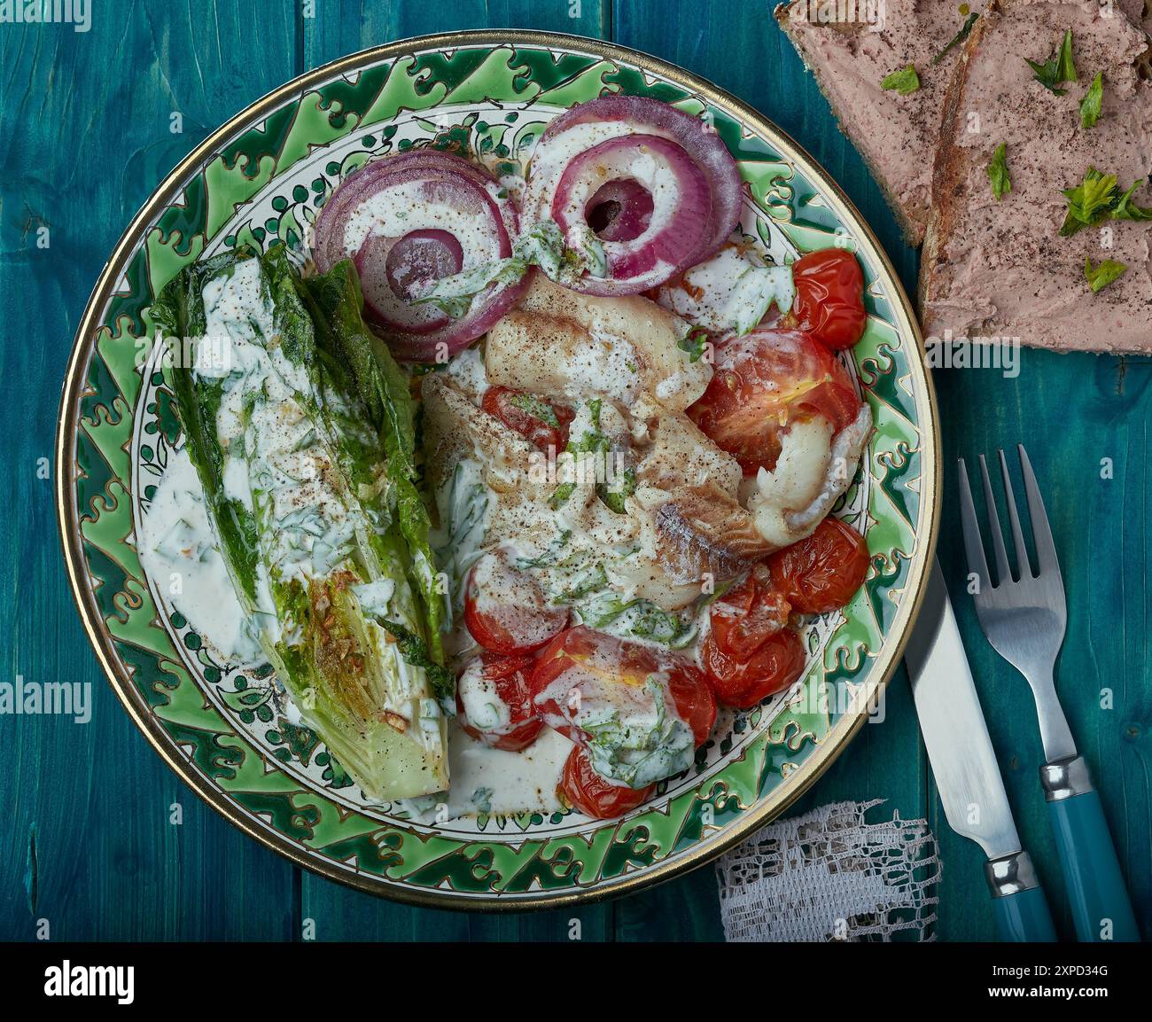 White fish with mixed salad and a fish sauce Stock Photo - Alamy