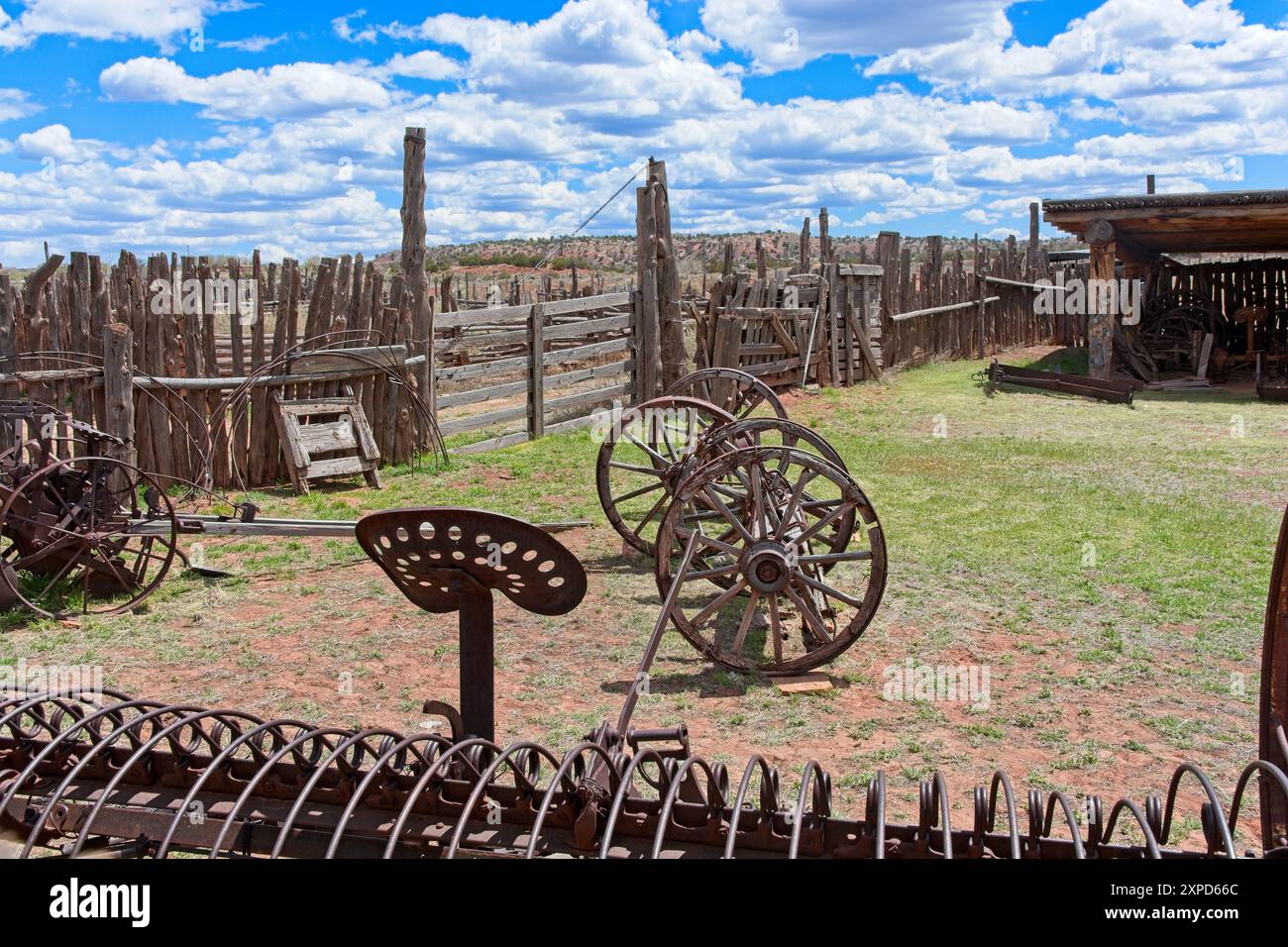 Antique farm equipment in rustic picket fenced yard Stock Photo - Alamy