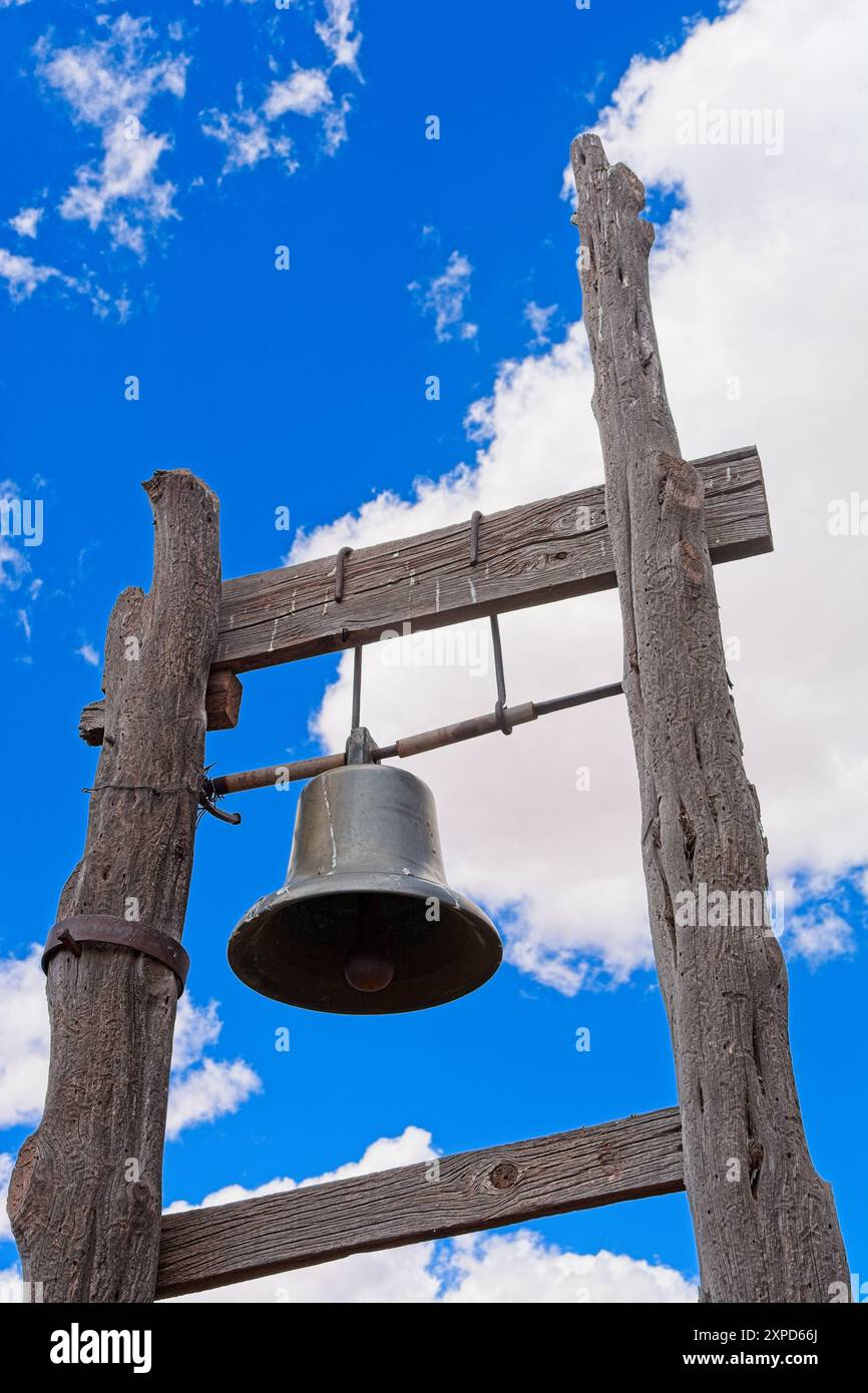Antique bronze bell under brightly lit clouds Stock Photo - Alamy