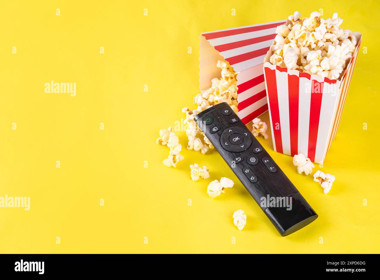 Paper bowl buckets of popcorn with TV remote on colorful bright ...