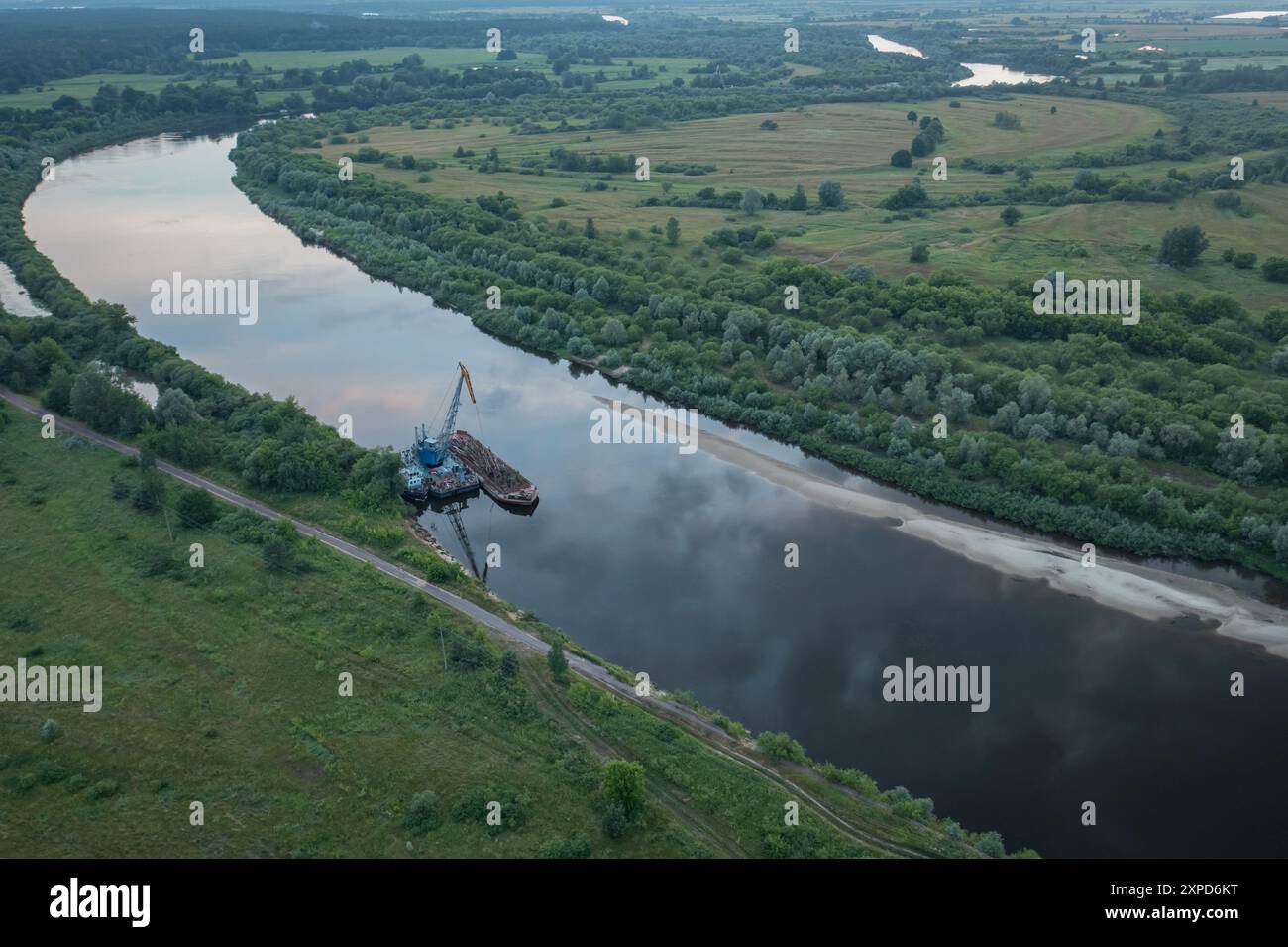 The process of cleaning the river from pollution. Barge and river crane ...