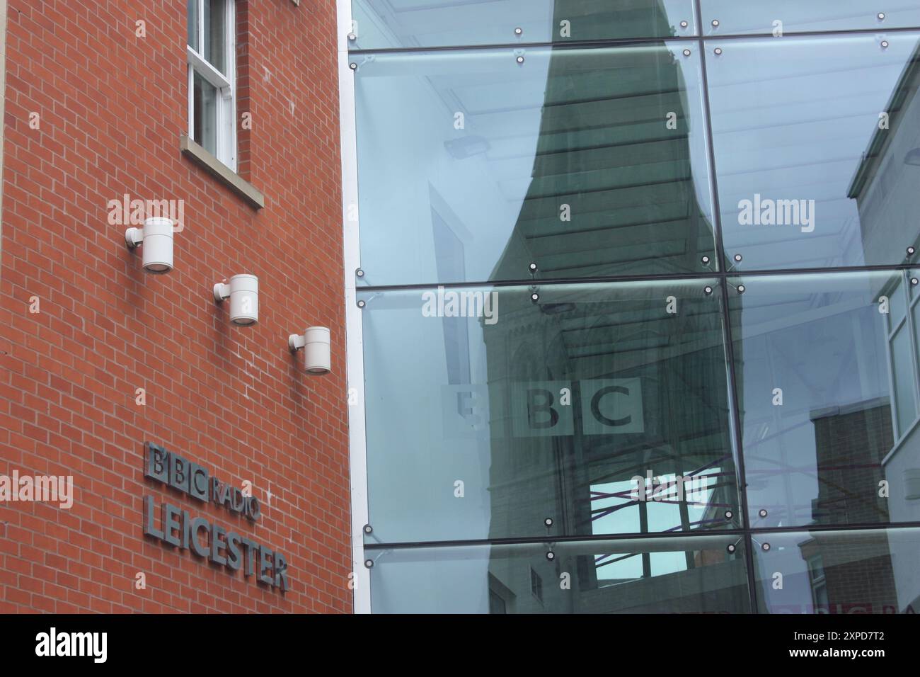 The glass entrance to BBC Radio Leicester with a reflection of the ...
