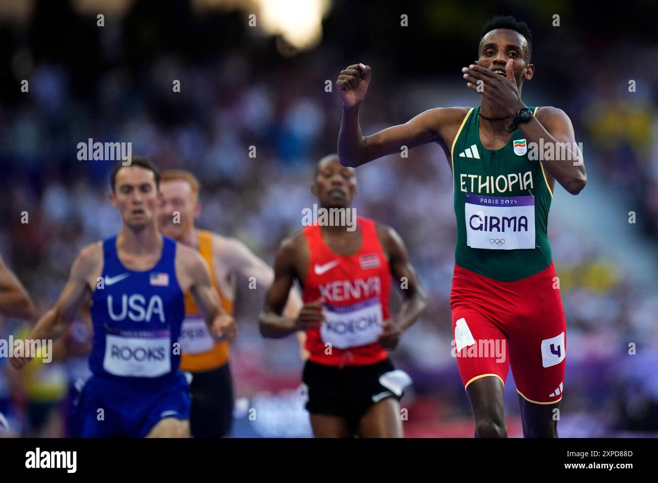 Lamecha Girma, of Ethiopia, reacts as he crosses the finish line to win ...
