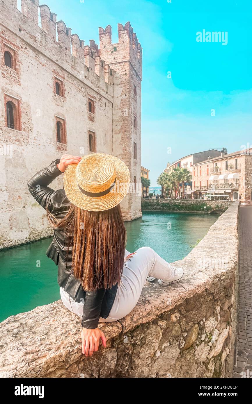Italy, Sirmione -Traveler woman visiting medieval village at Garda Lake ...