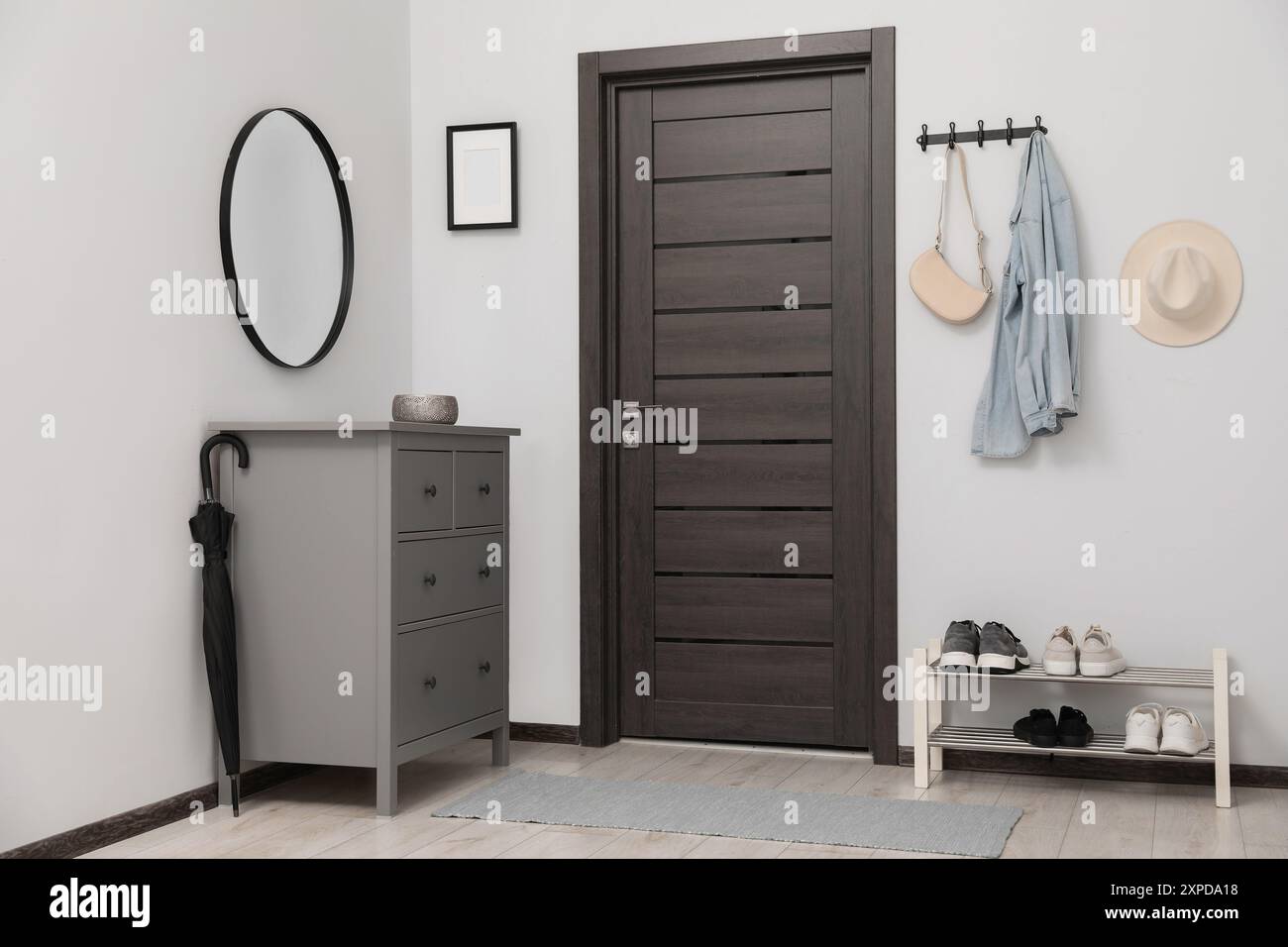 Chest of drawers, mirror and shoe storage bench in hallway. Interior ...