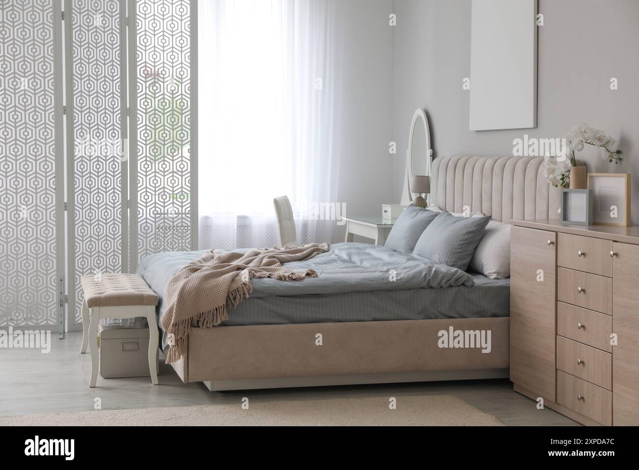 Folding screen, mirror and comfortable bed in bedroom. Interior design ...