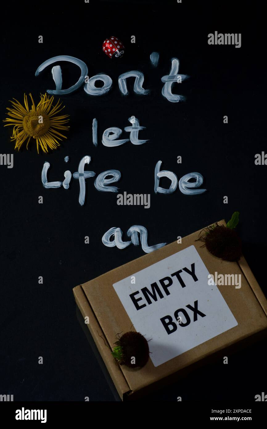 Don't let life be an empty box - handwritten in white letters on black ...