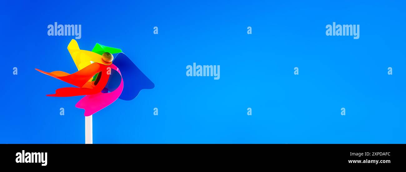 Colorful paper pinwheel isolated on a blue sky background - Web design ...