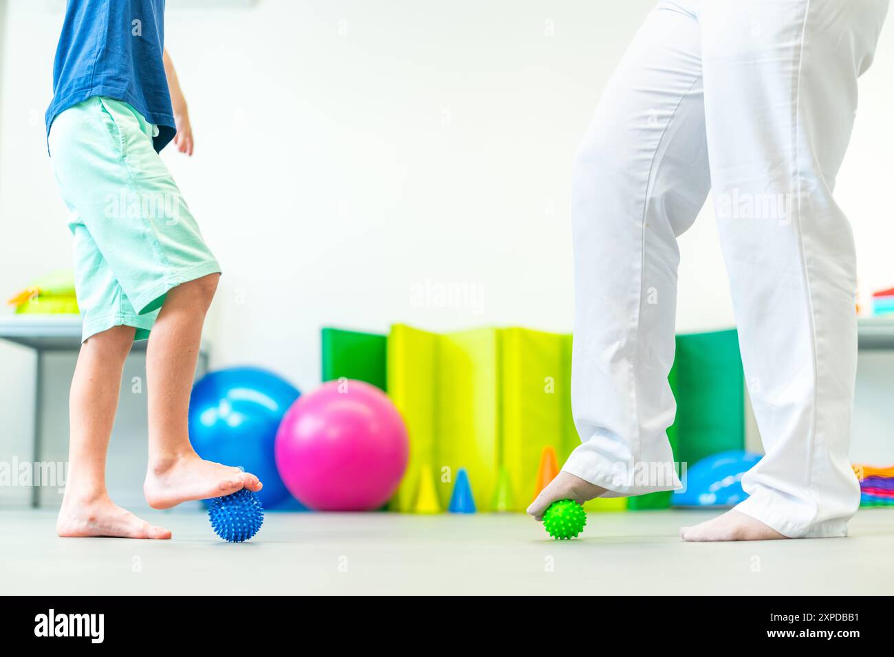 Child and female physical therapist during session. Child exercising ...