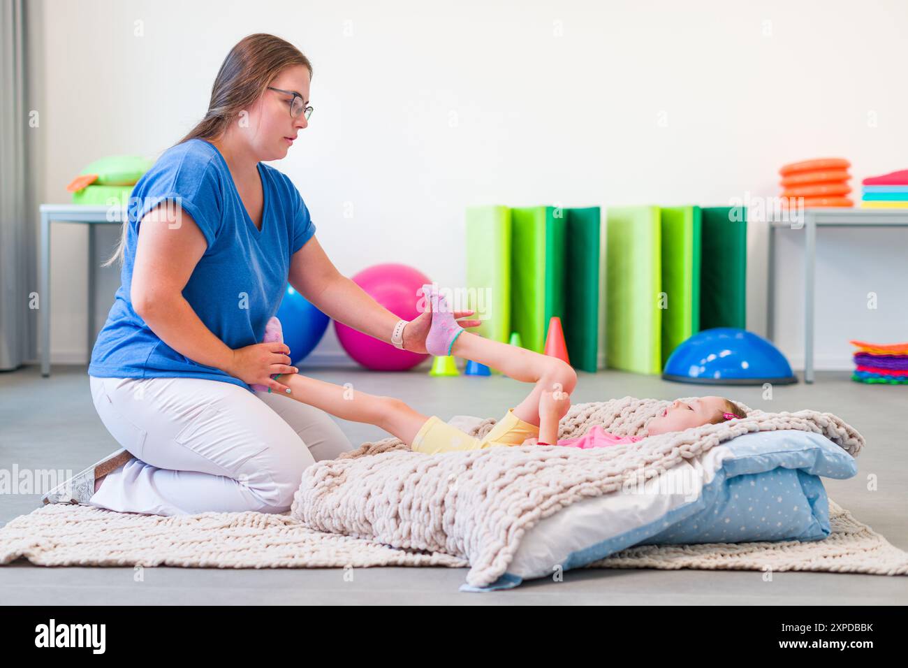 Child with physical disability in physical therapy session. Child ...