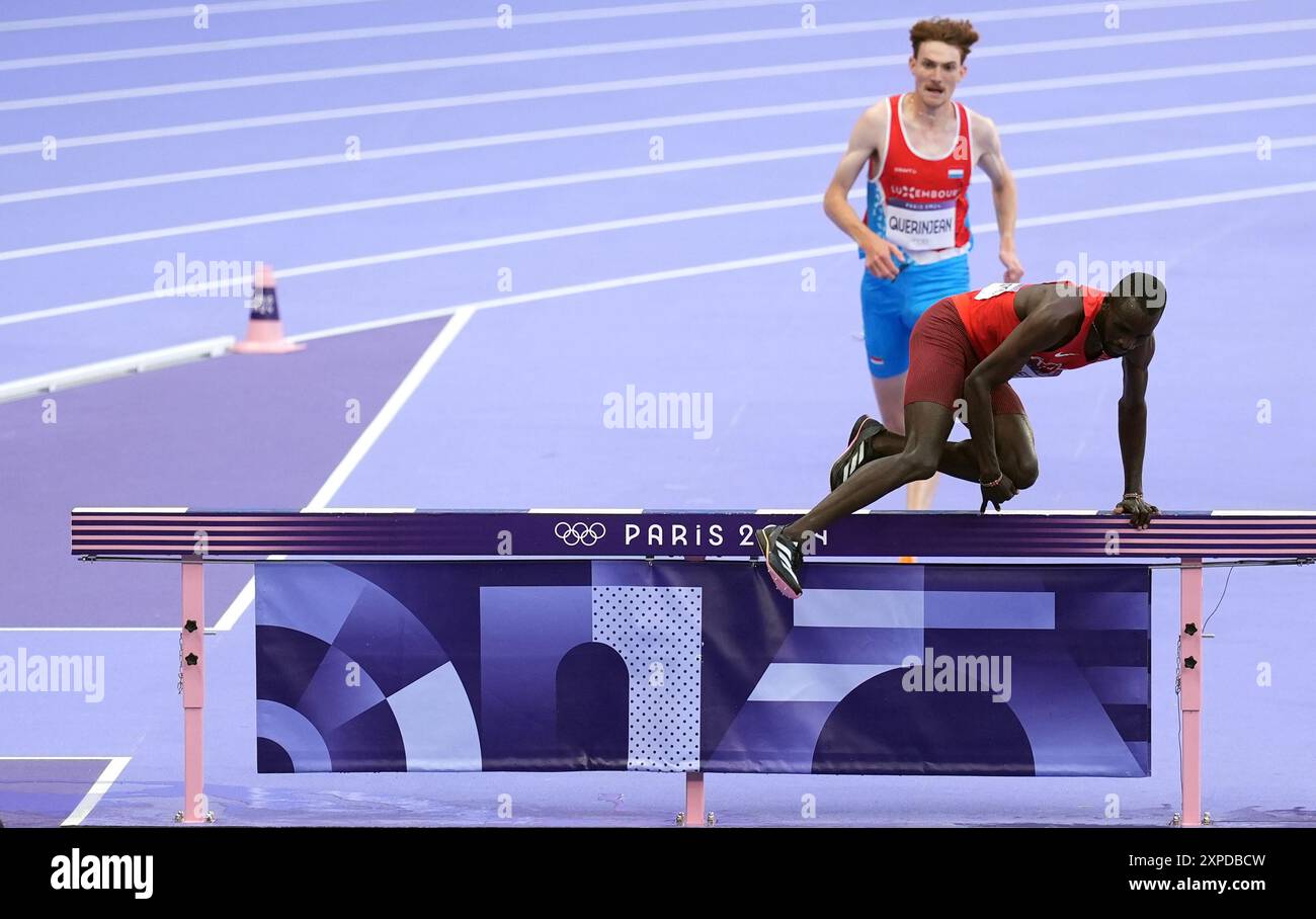 Kenya's Amos Serem climbs over the steeple, having initially avoided it ...