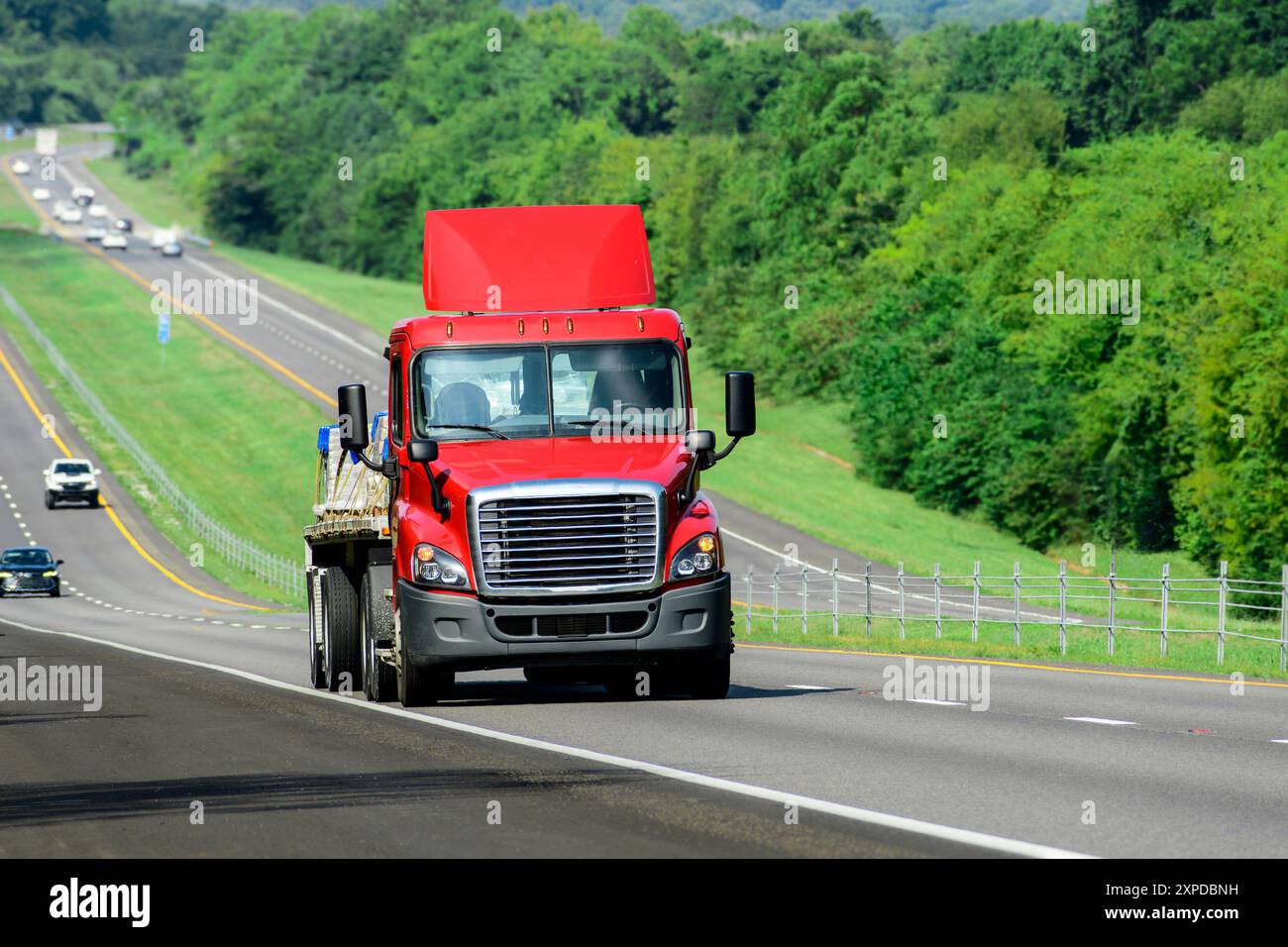 Horizontal shot of a red truck on an interstate highway with copy space ...
