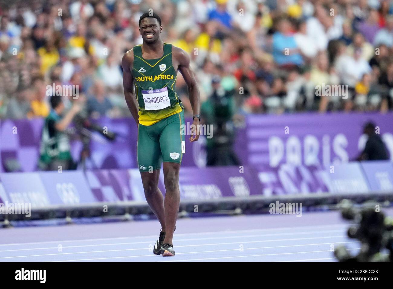 Benjamin Richardson, of South Africa, grimaces and abandons a men's 200 ...