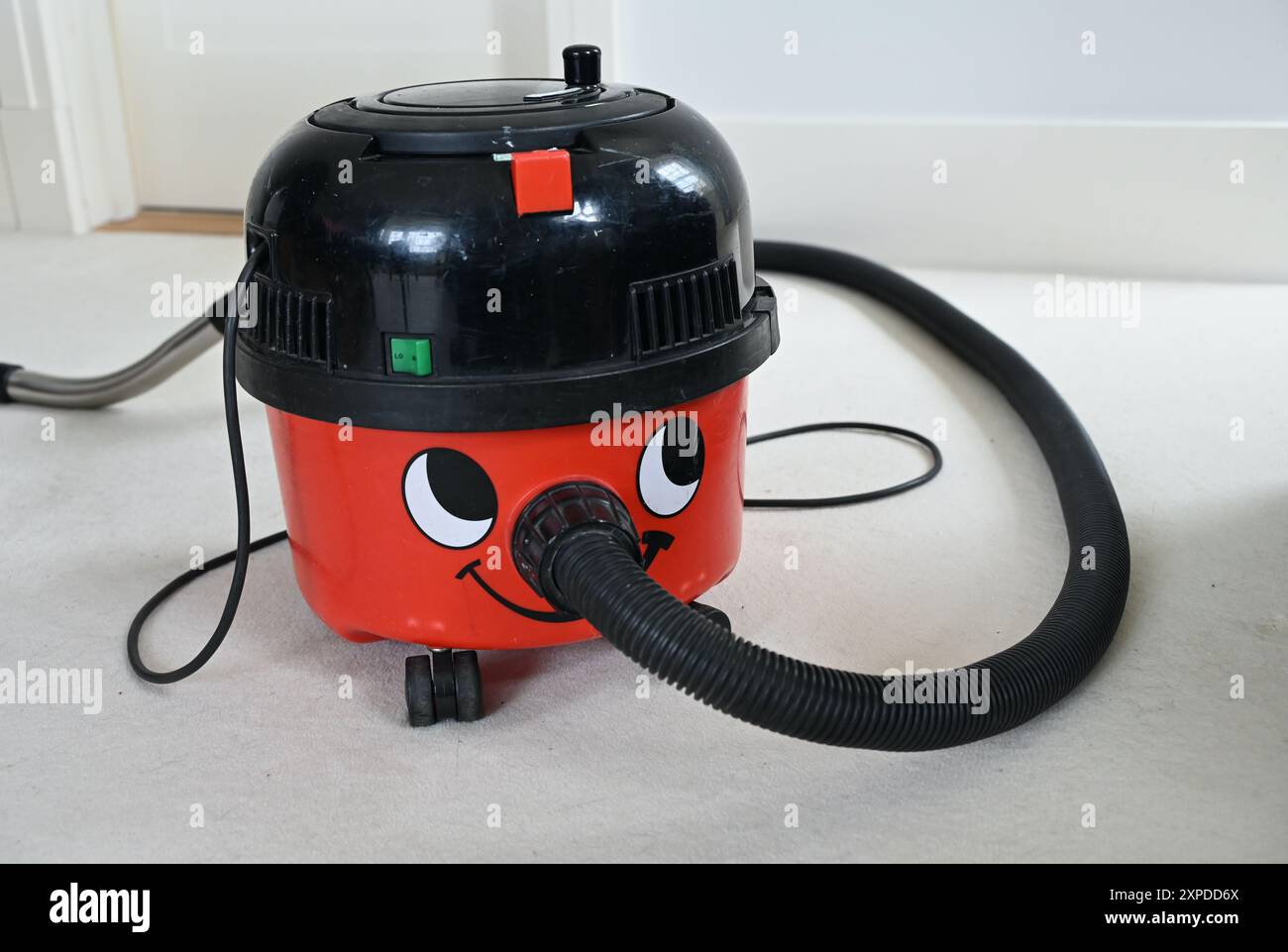 Old British vacuum cleaner Henry with funny design in home interior ...