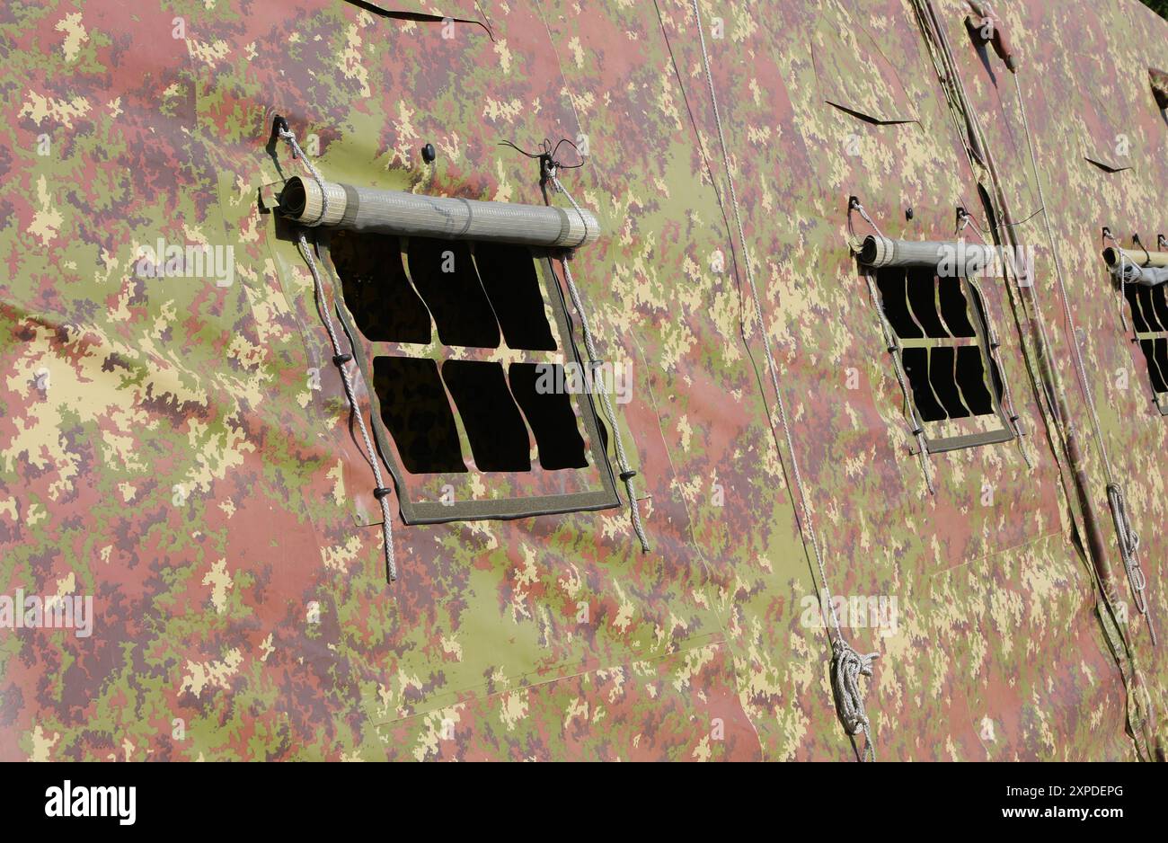 open windows of a military tent with camouflage fabric to prevent ...