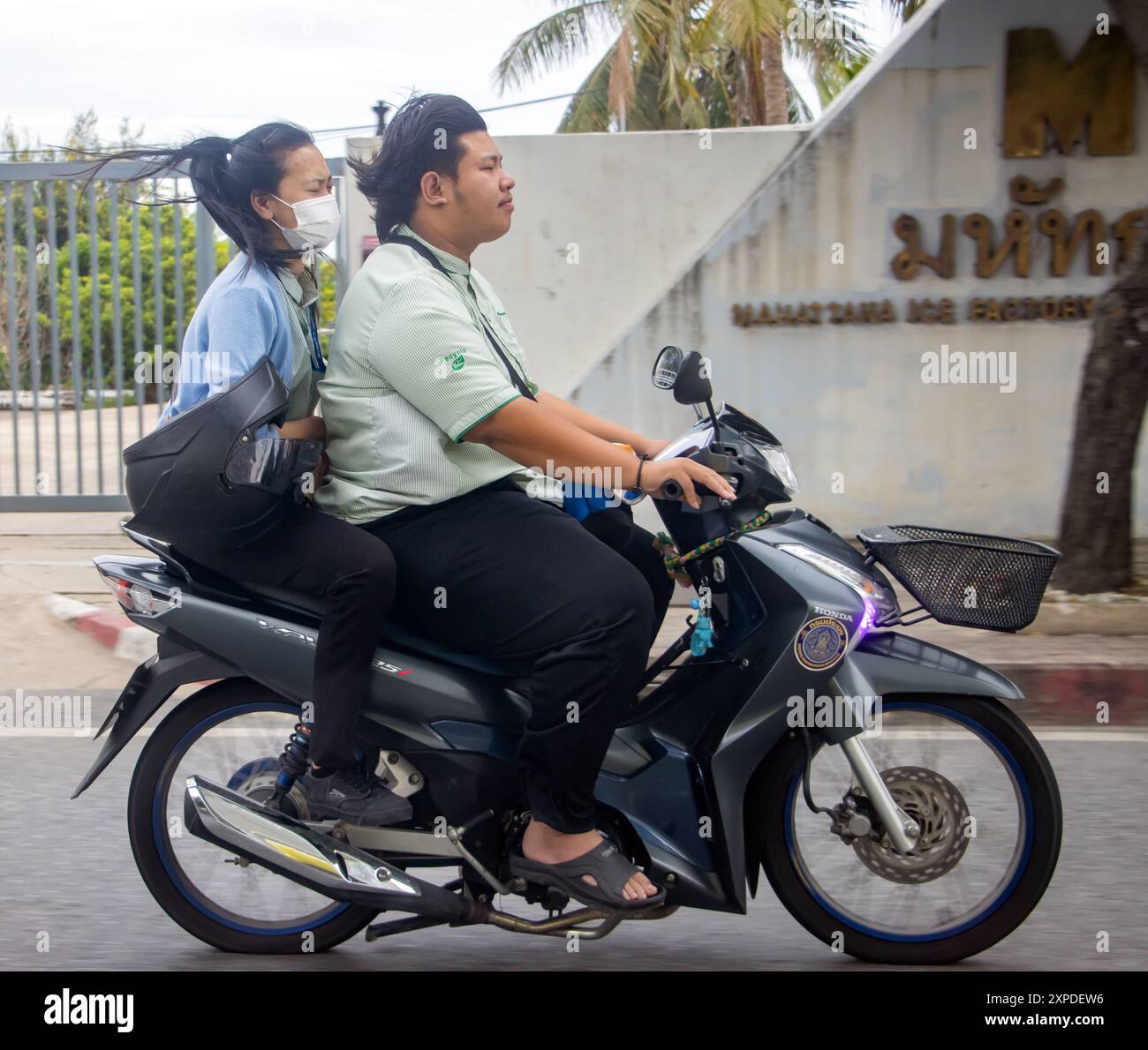 BANGKOK, THAILAND, JUNE 24 2024, A couple is riding a motorcycle in the ...