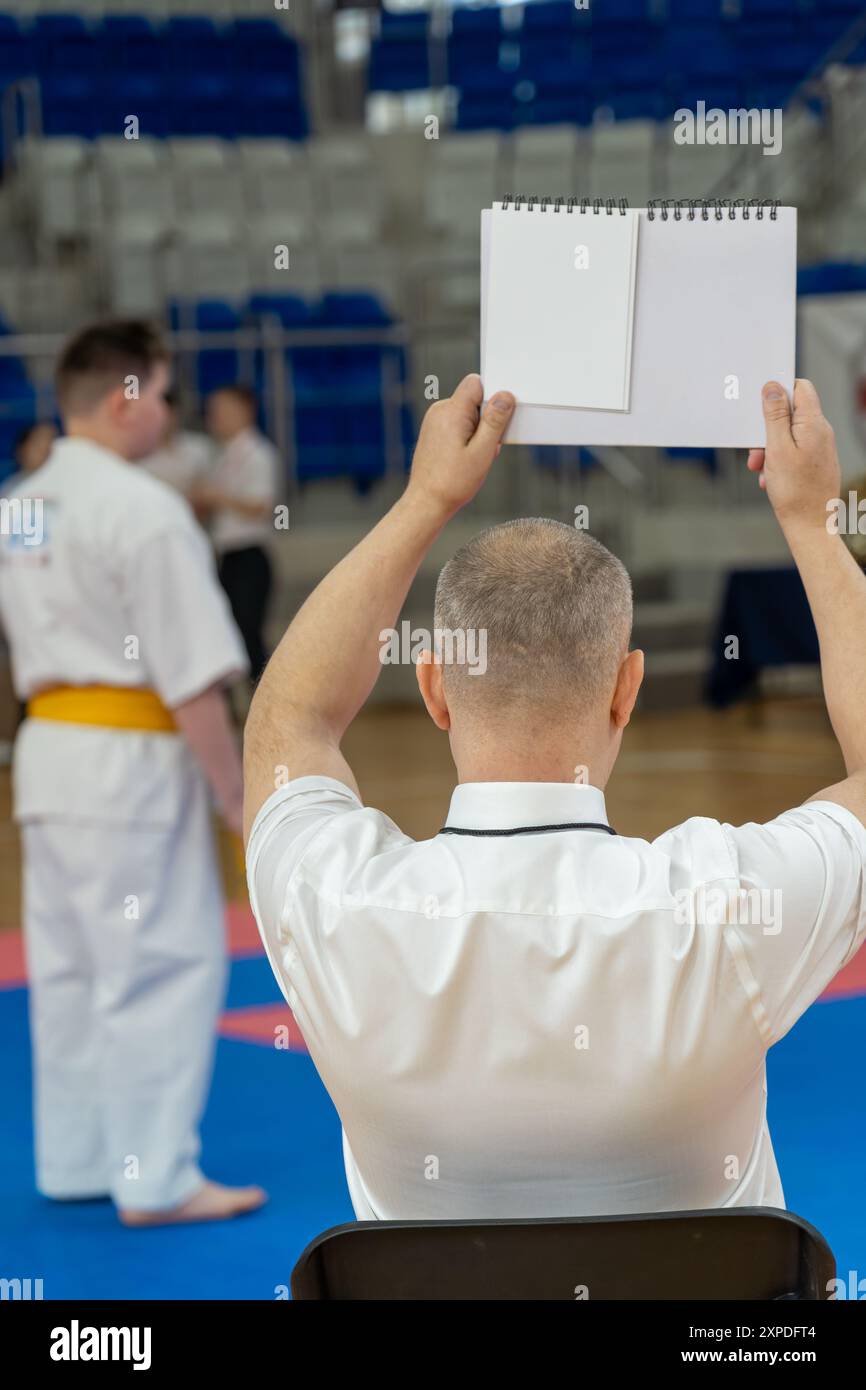 The karate referee shows marks during martial art competition. Copy ...