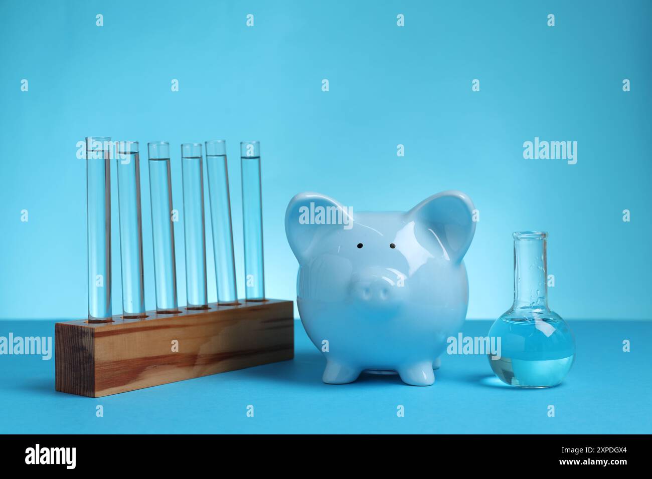 Water save concept. Piggy bank, laboratory flask and test tubes with ...