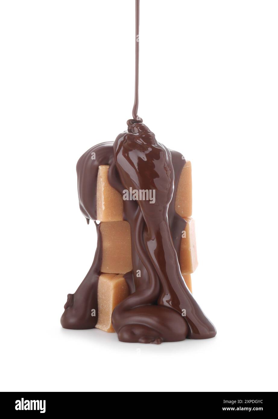 Pouring delicious melted chocolate onto caramel candies isolated on ...
