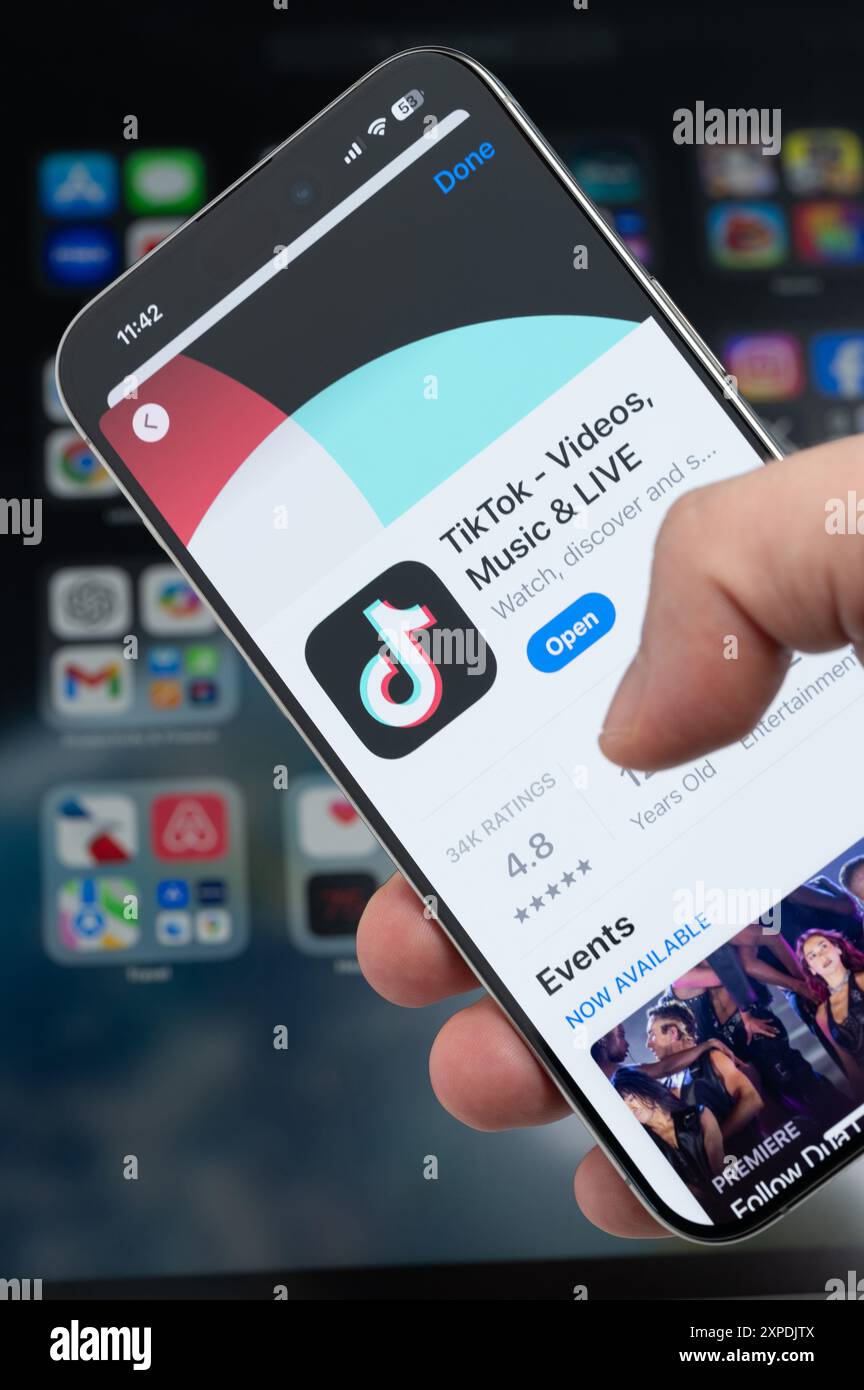 New York, USA - August 5, 2024: Smartphone in hand with TikTok app on screen macro close up view ...