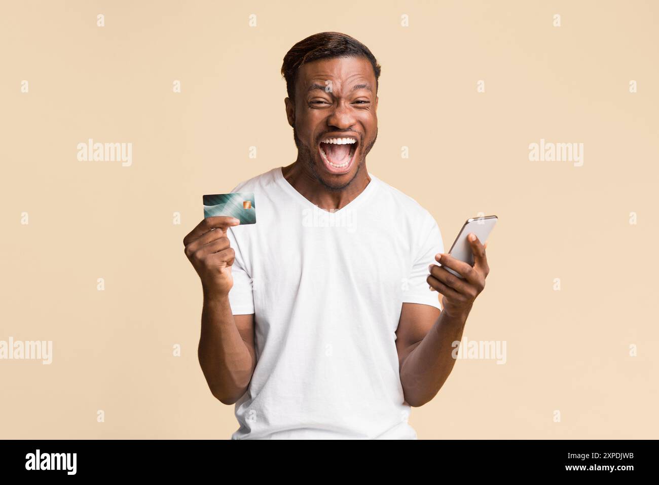 Afro Guy Holding Phone And Credit Card Shouting, Yellow Background ...