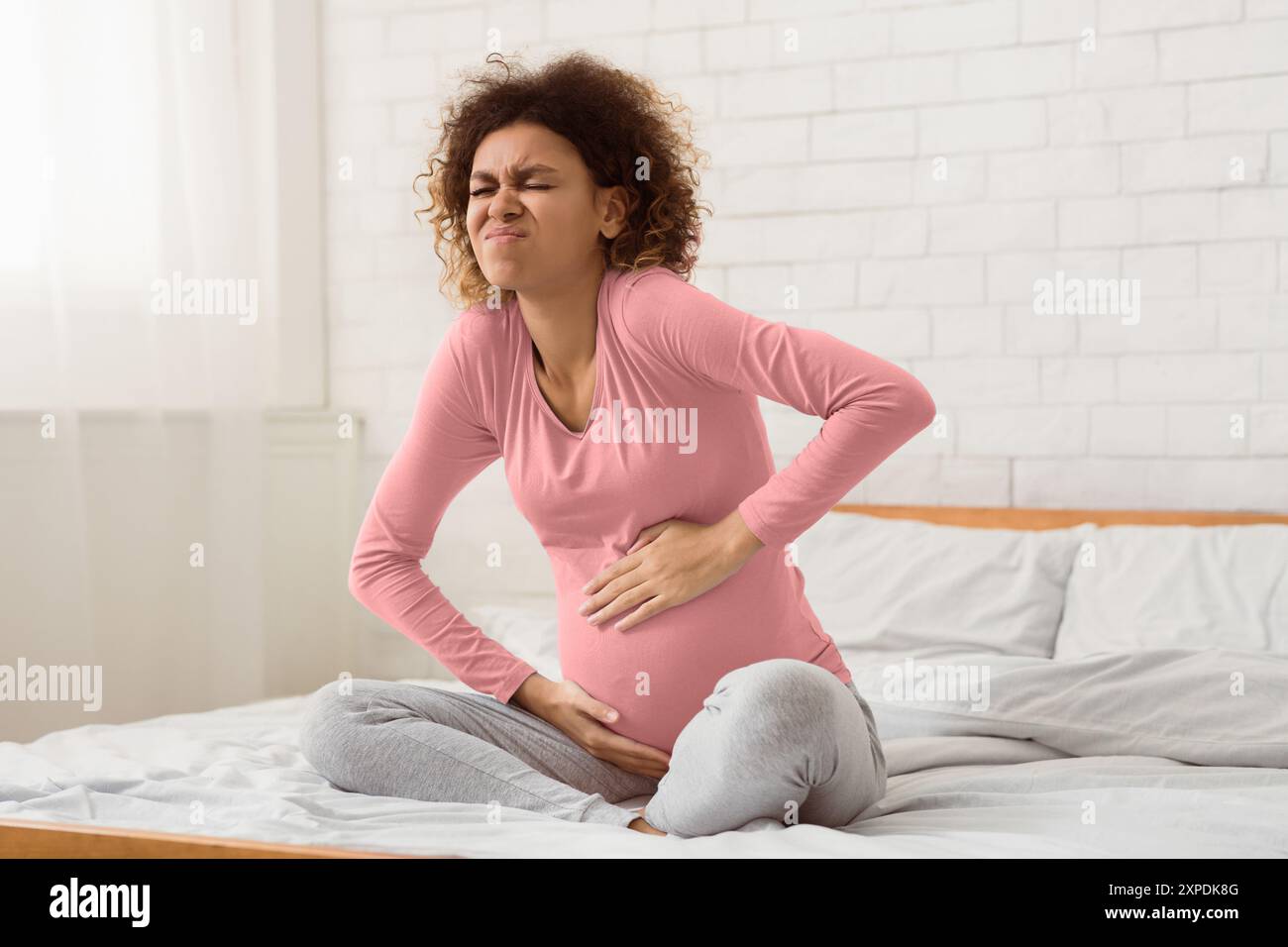 Labor contractions. Pregnant woman having pain in belly Stock Photo - Alamy