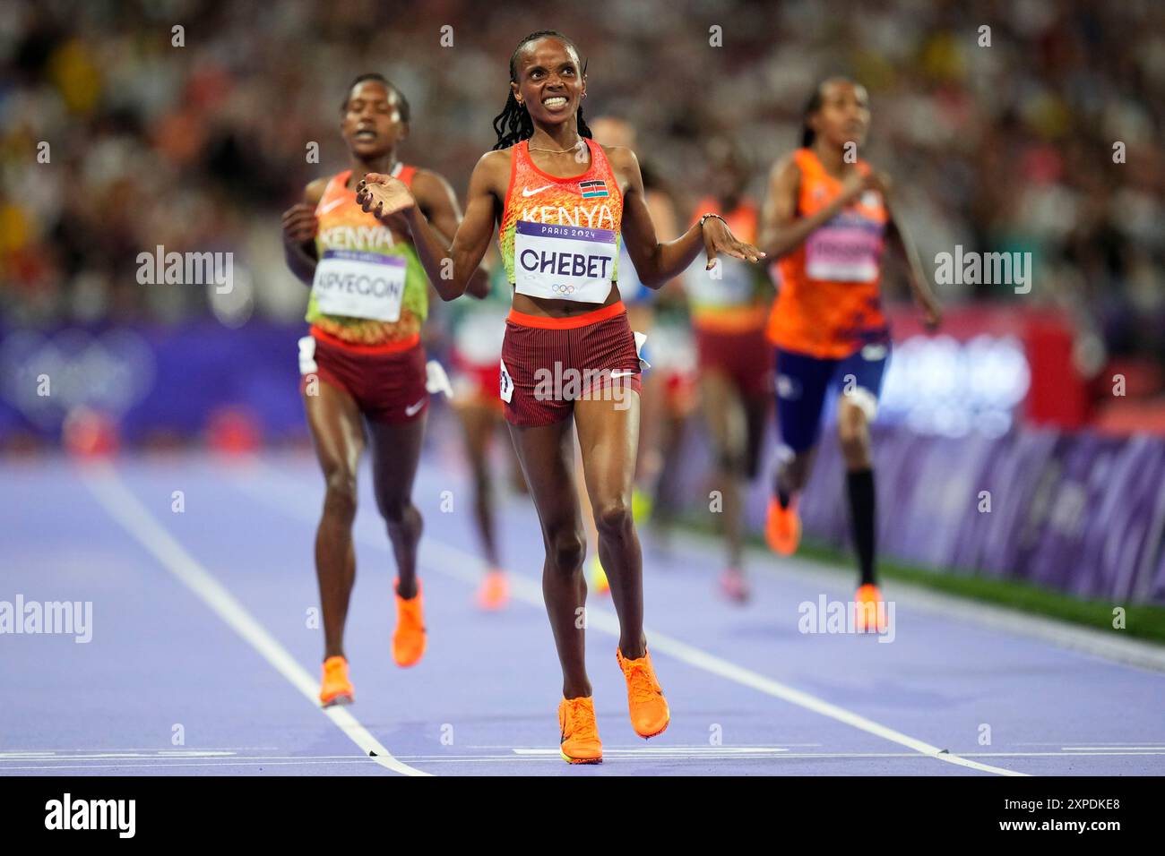 Beatrice Chebet, of Kenya, reacts as she crosses the finish line to win ...