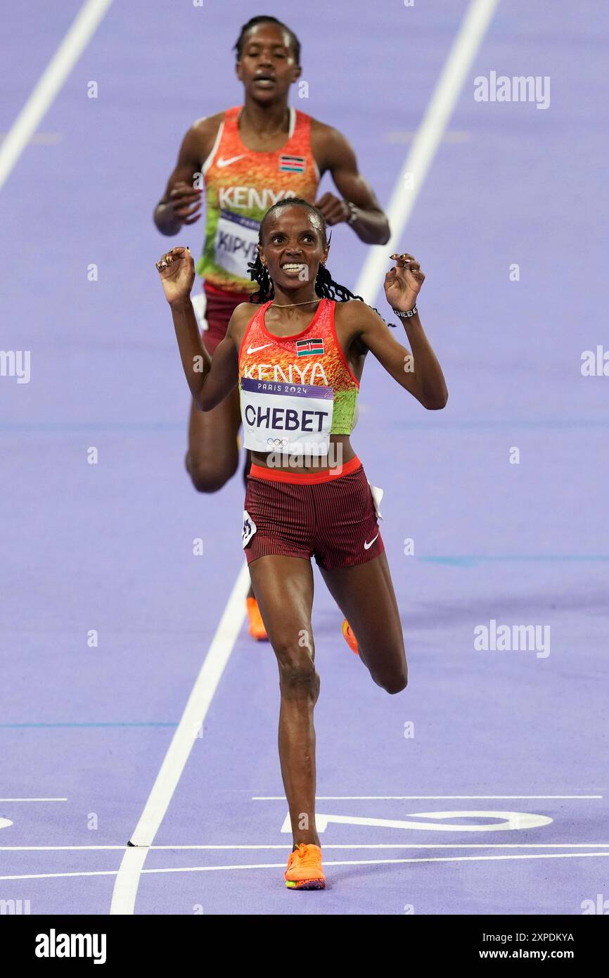 Beatrice Chebet, of Kenya, crosses the finish line to win the women's ...
