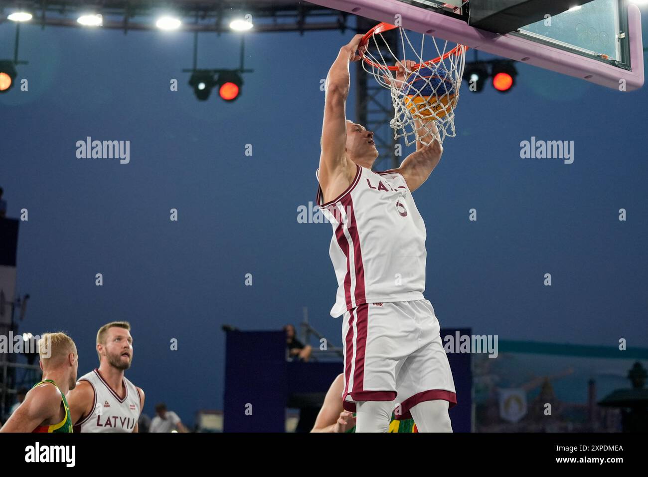 Latvia's Francis Lacis (6) dunks the ball against Lithuania during a ...