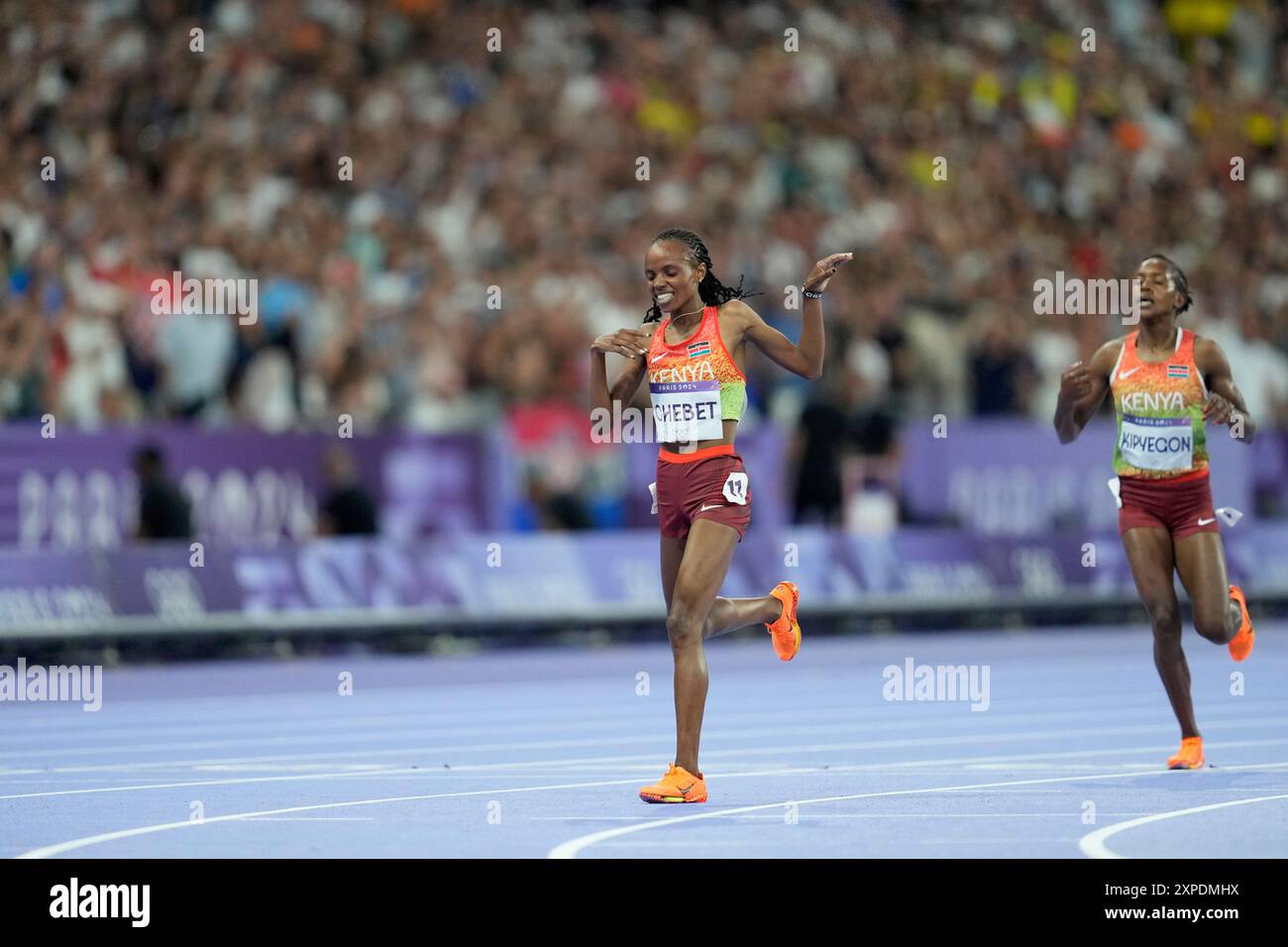 Beatrice Chebet, of Kenya, crosses the finish line to win the women's ...