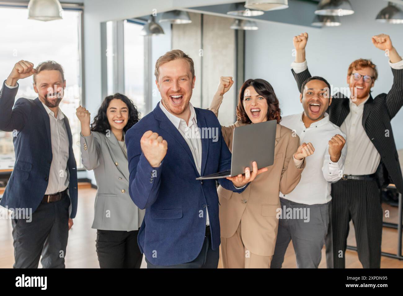 Business Team Celebrating Success in Modern Office Stock Photo - Alamy