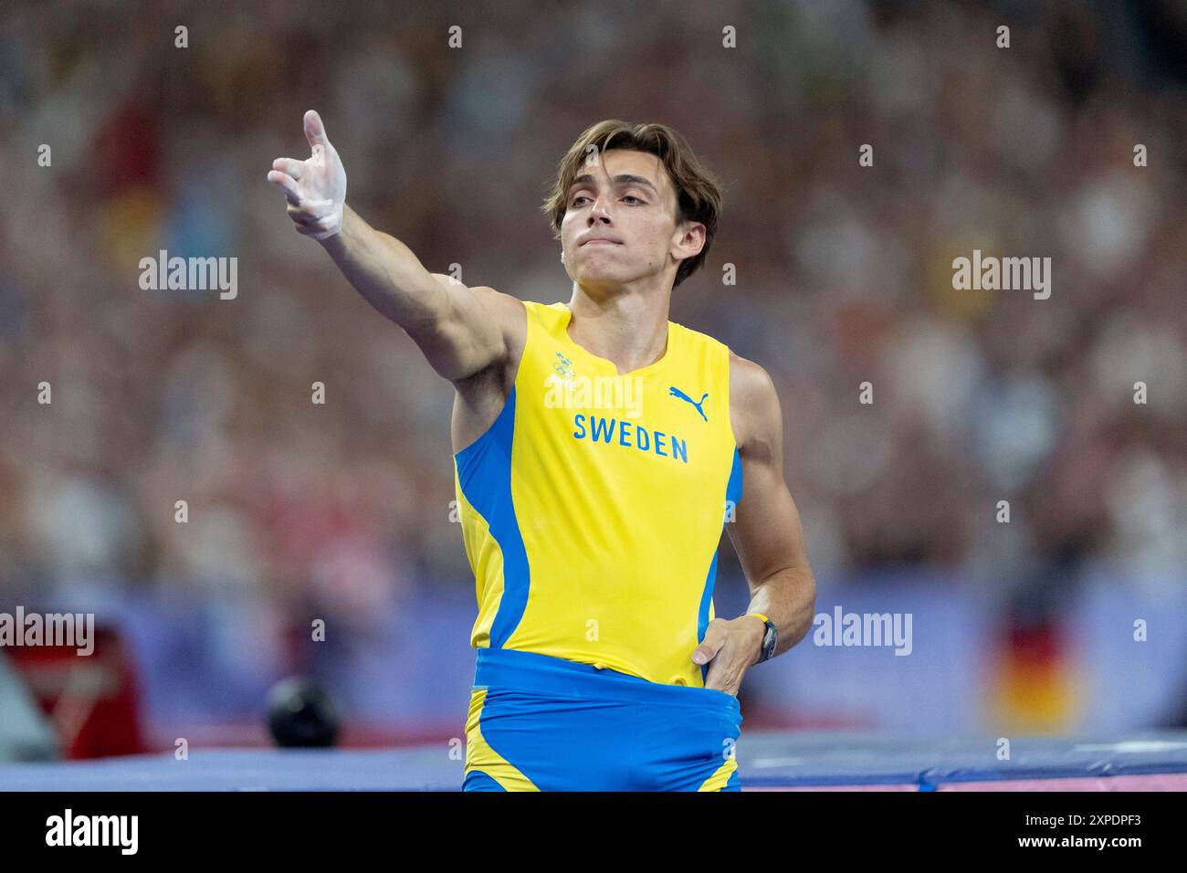 Armand Duplantis, of Sweden, reacts after setting a new Olympic record ...