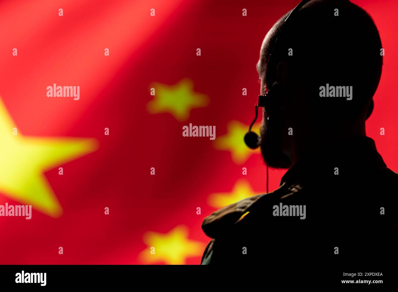 Chinese military dispatcher using headset mic, offering information to commanders fighting on ...