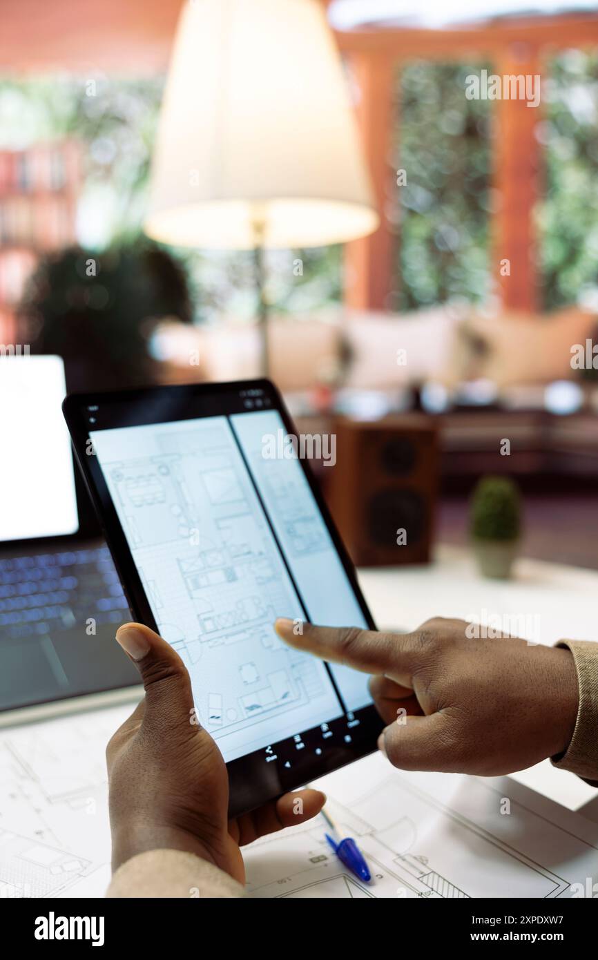 Small business owner evaluating office space blueprints and layouts for ...